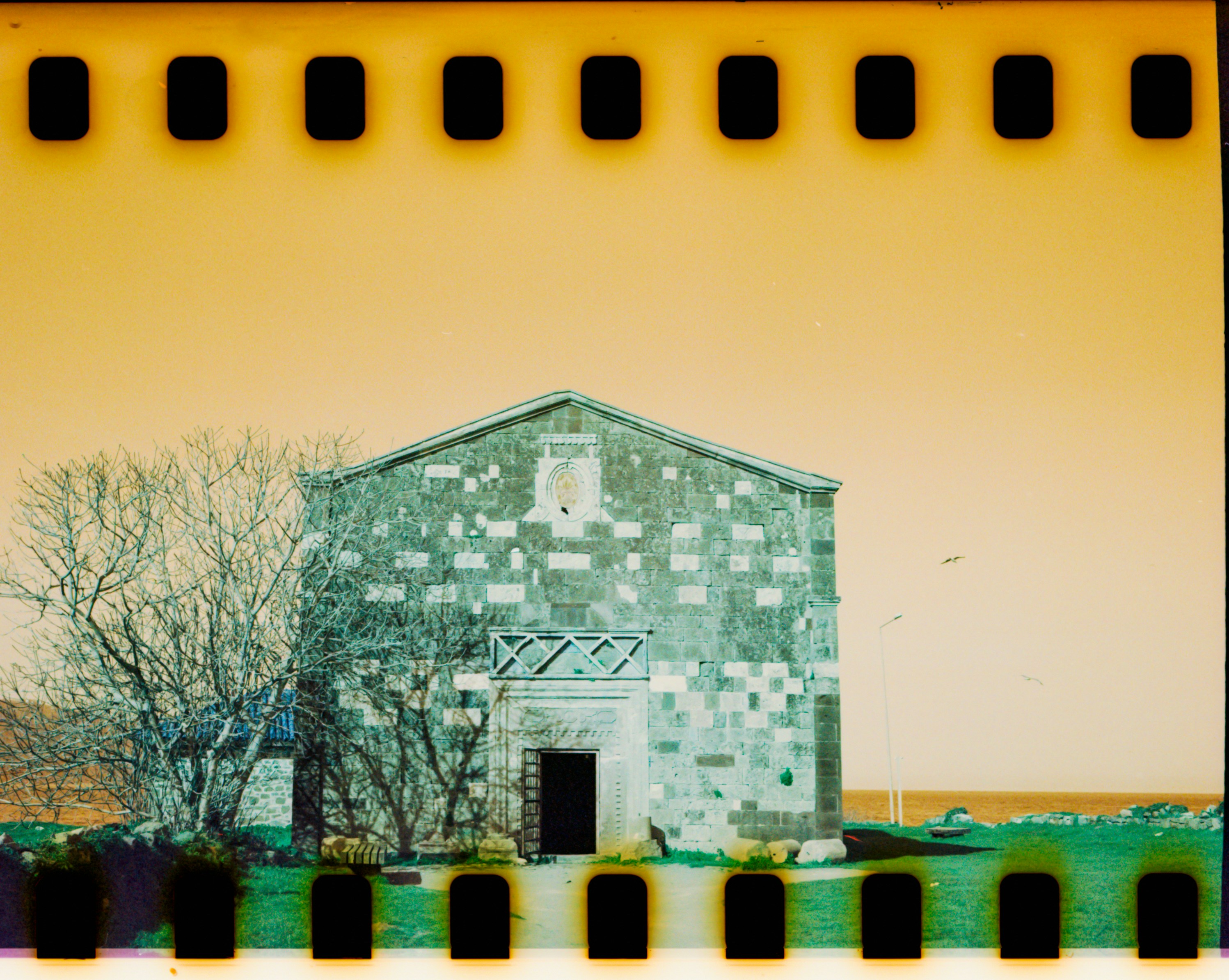 Patchwork Stone Facade by the Sea at Saffron Dusk
