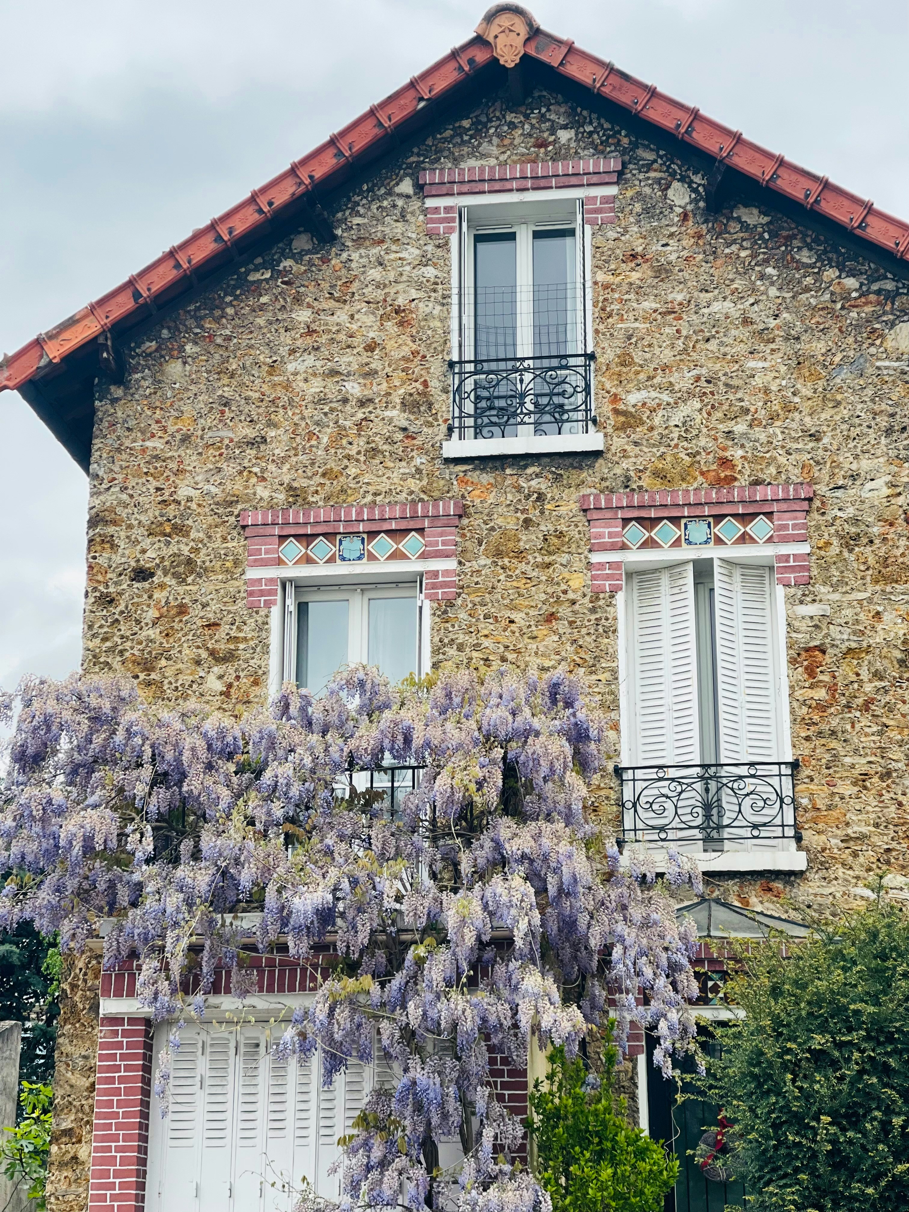 Lilac Cascade Over a Stone Facade