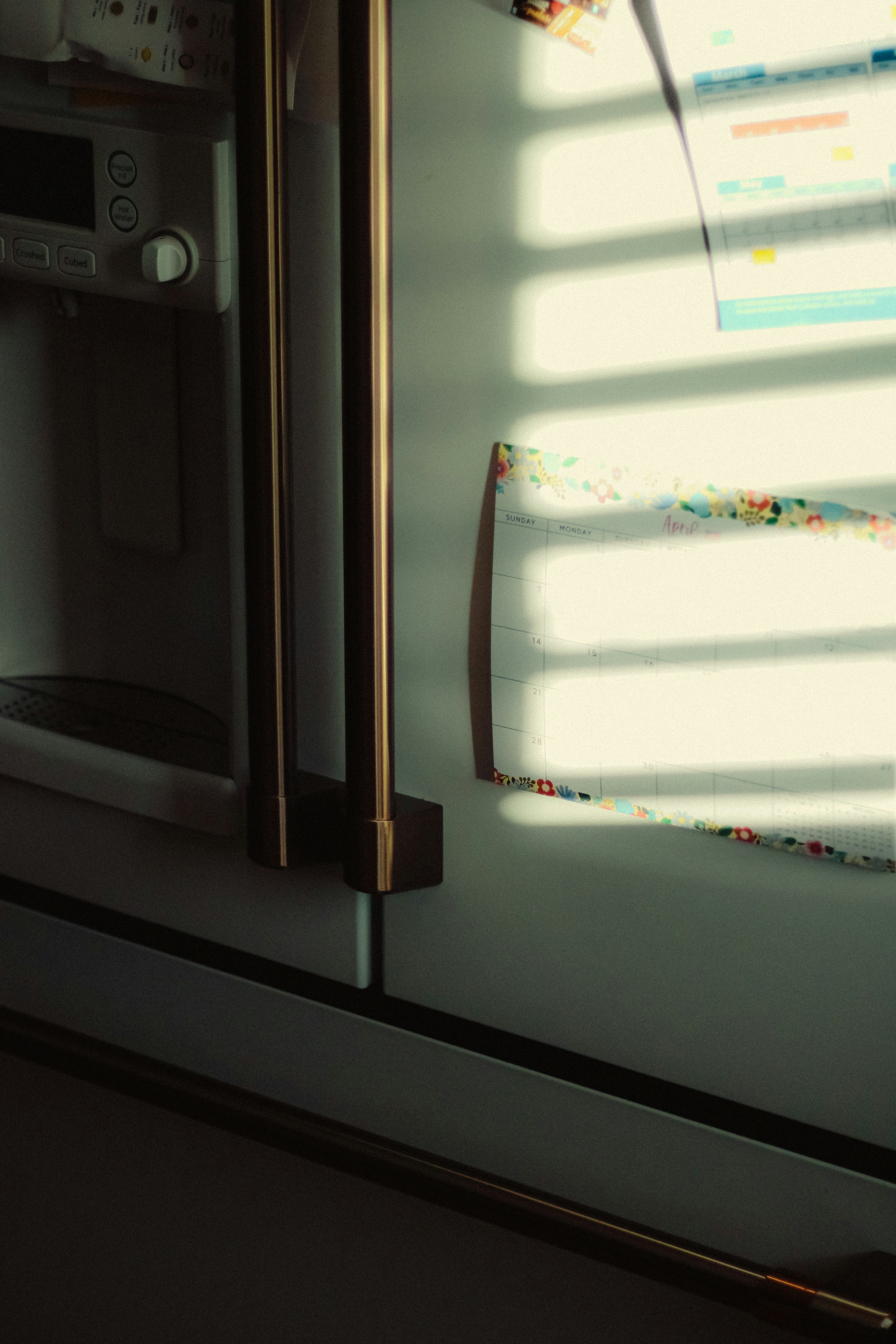 Shadowed refrigerator glare across a floral note pad