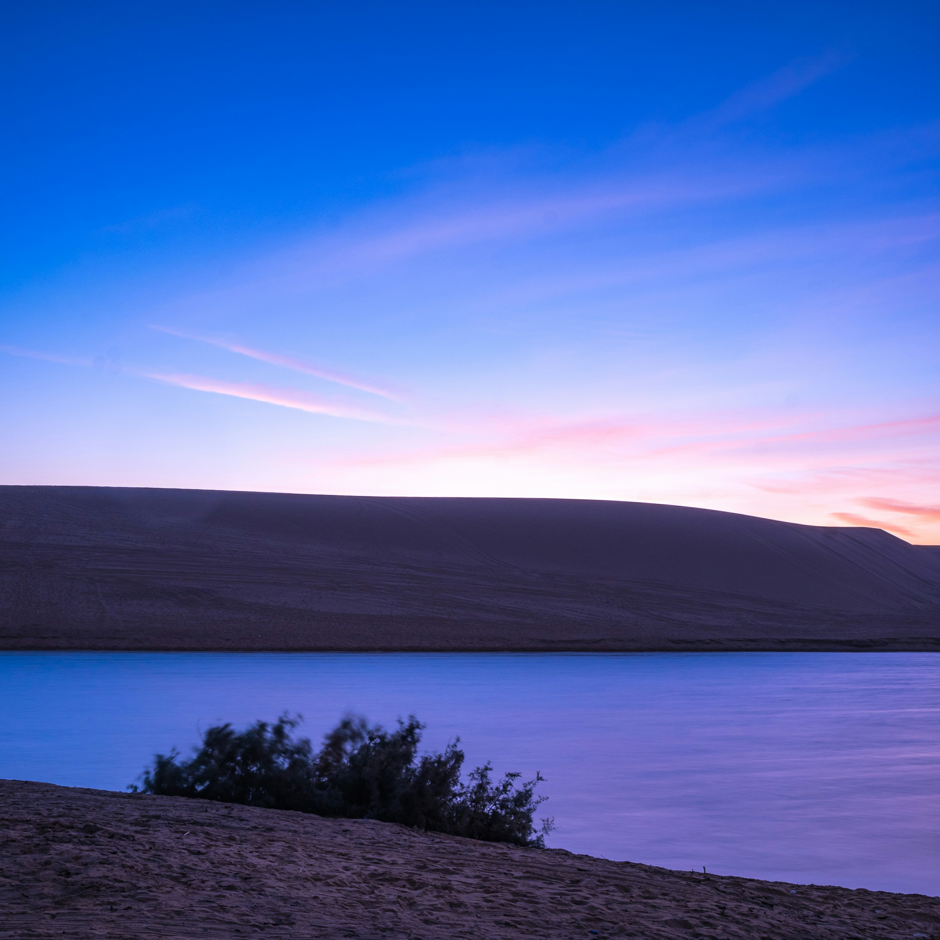 Twilight Confluence: Velvet Sky over a Desert Dune and Quiet Water