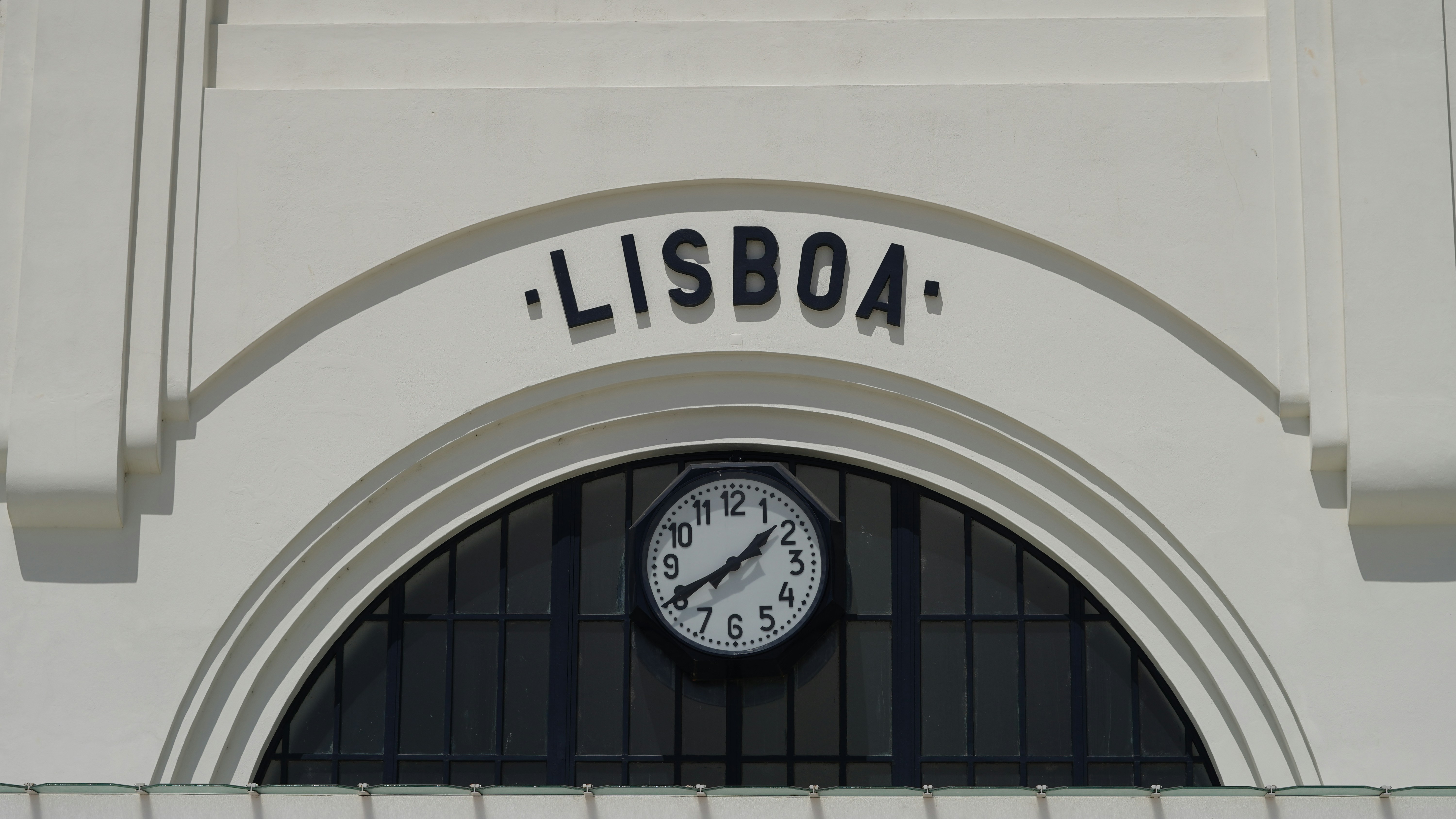Time Under the Arch: Lisbon's White Facade Framing a Central Clock