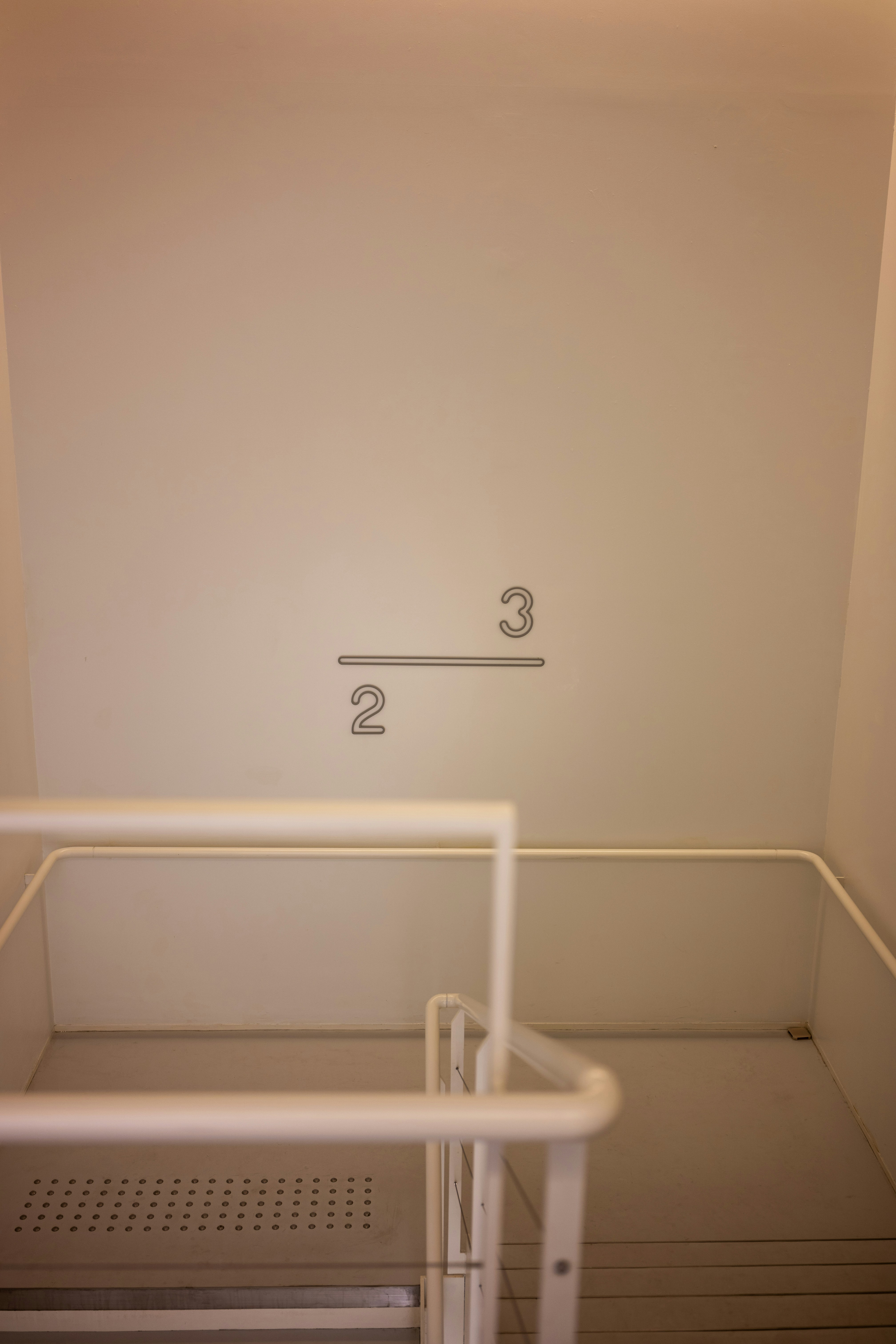 Between Levels: The Quiet Elevator Wall Marked by 2 and 3