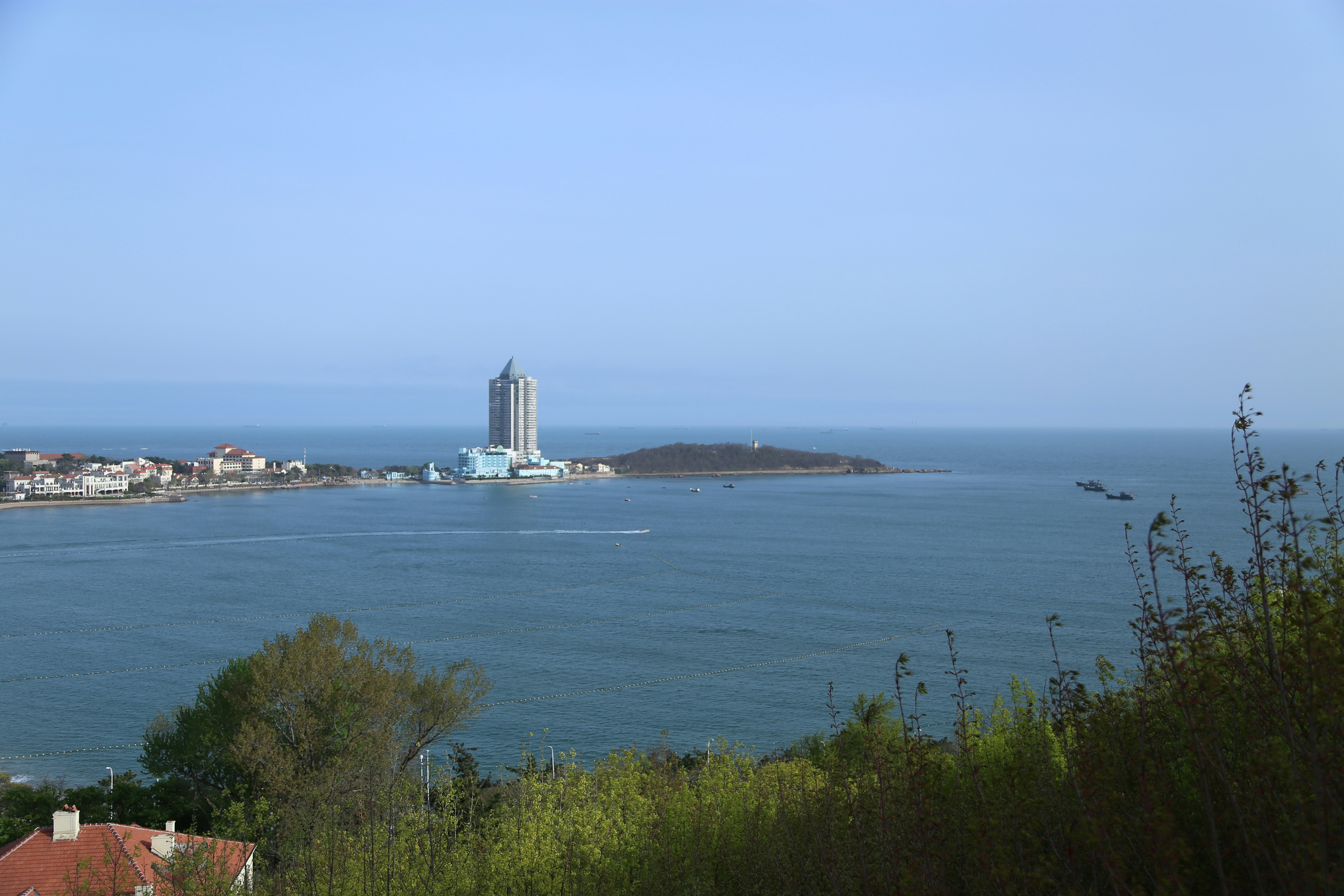 Harbor Sentinel: A Tall White Tower Guarding the Calm Sea