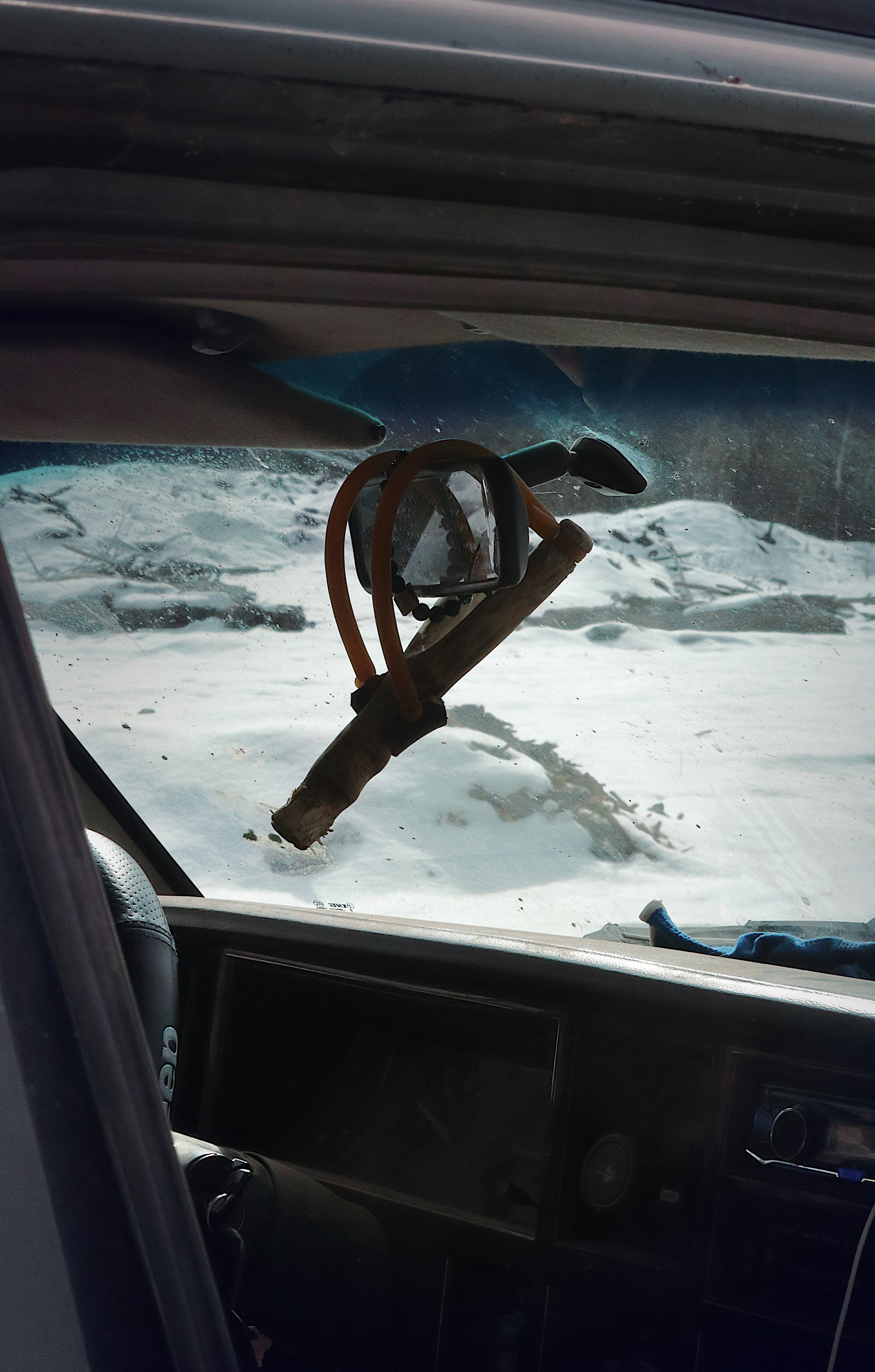 Rearview Relic: A Weathered Tool Floats in a Snow-Dusted Cabin