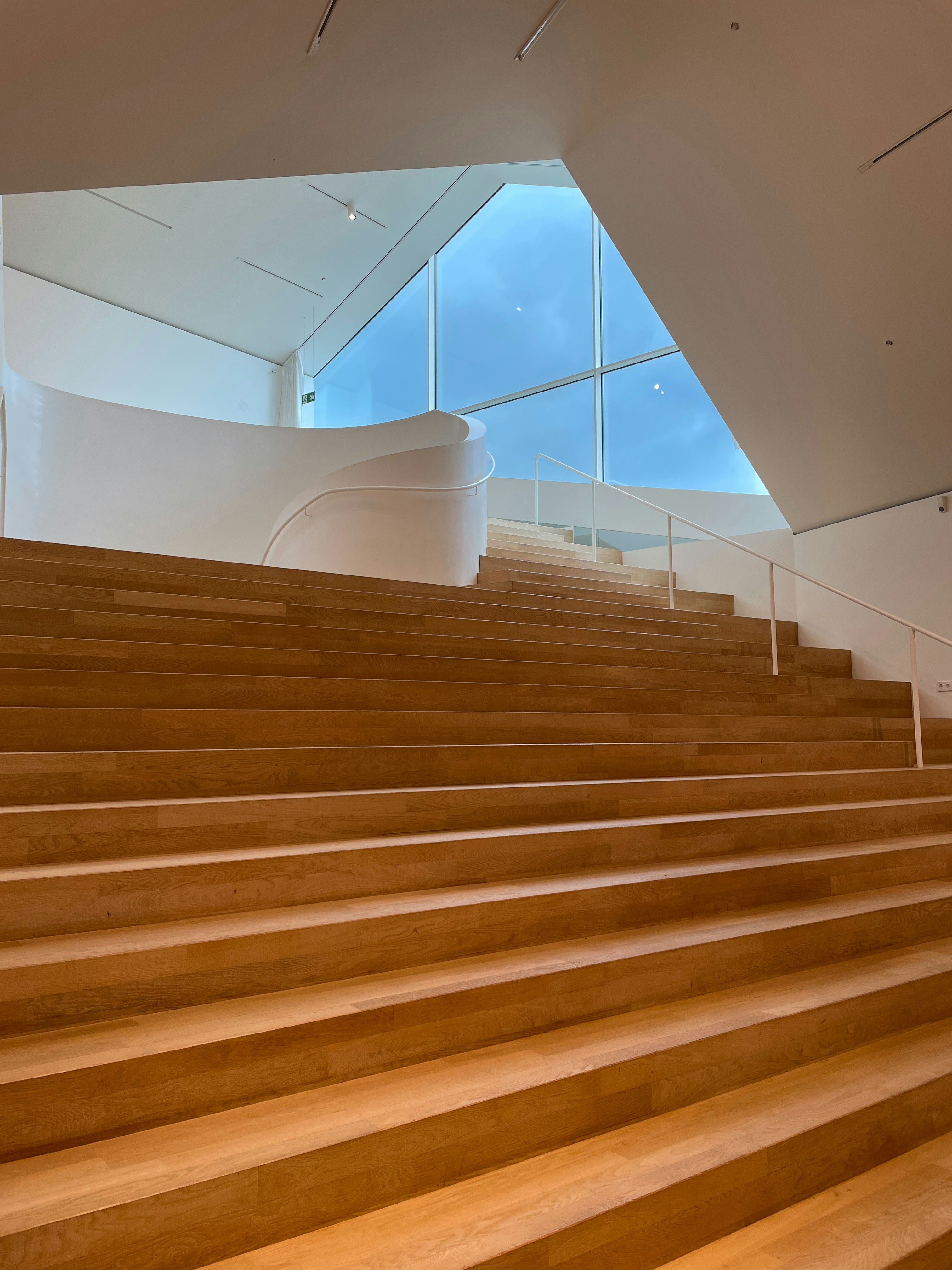 A set of wooden stairs leading up to a large window photo – Free Wood ...