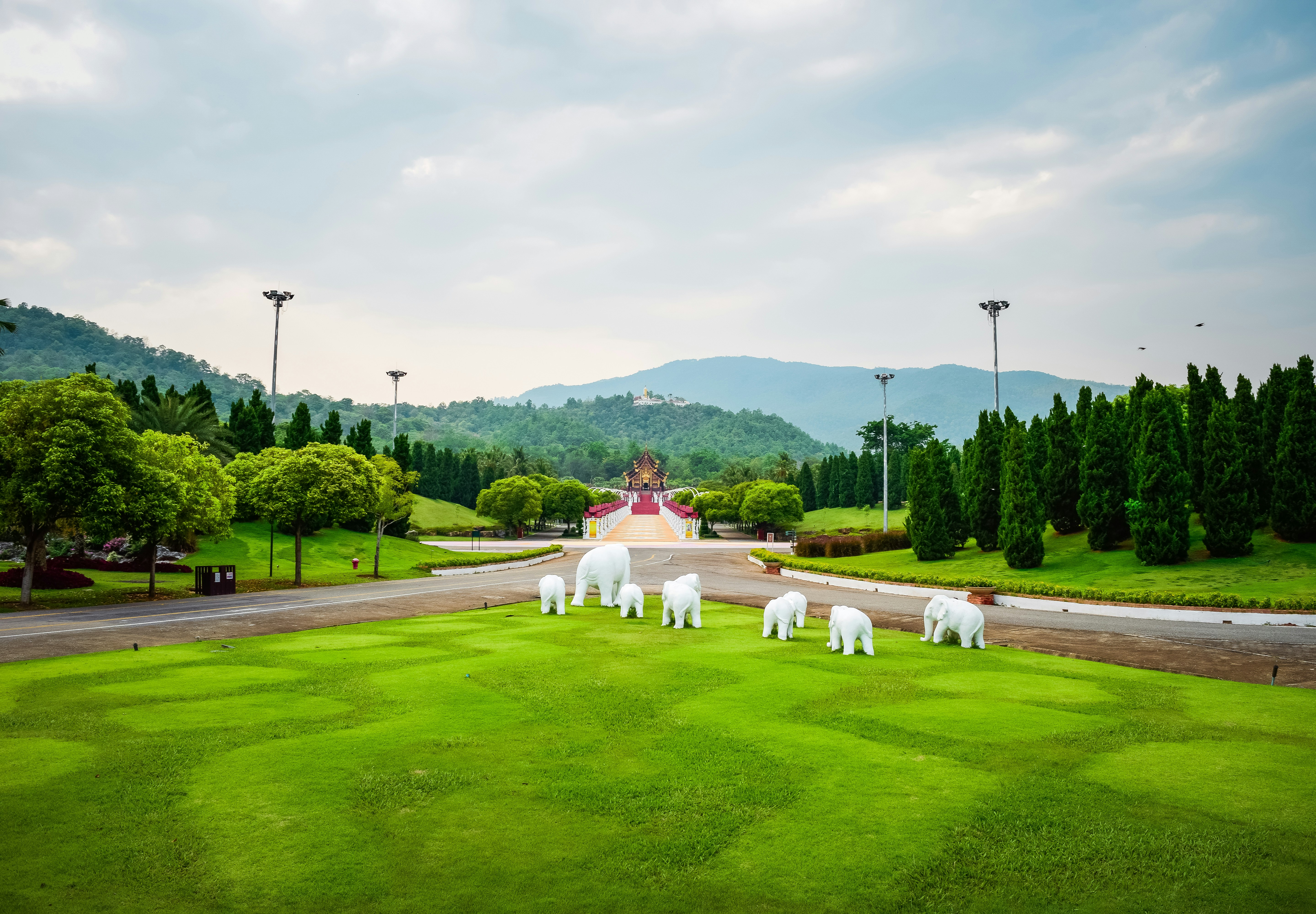 Symmetrical Park Grounds with Polar-White Sculptures Guiding to a Central Red Structure