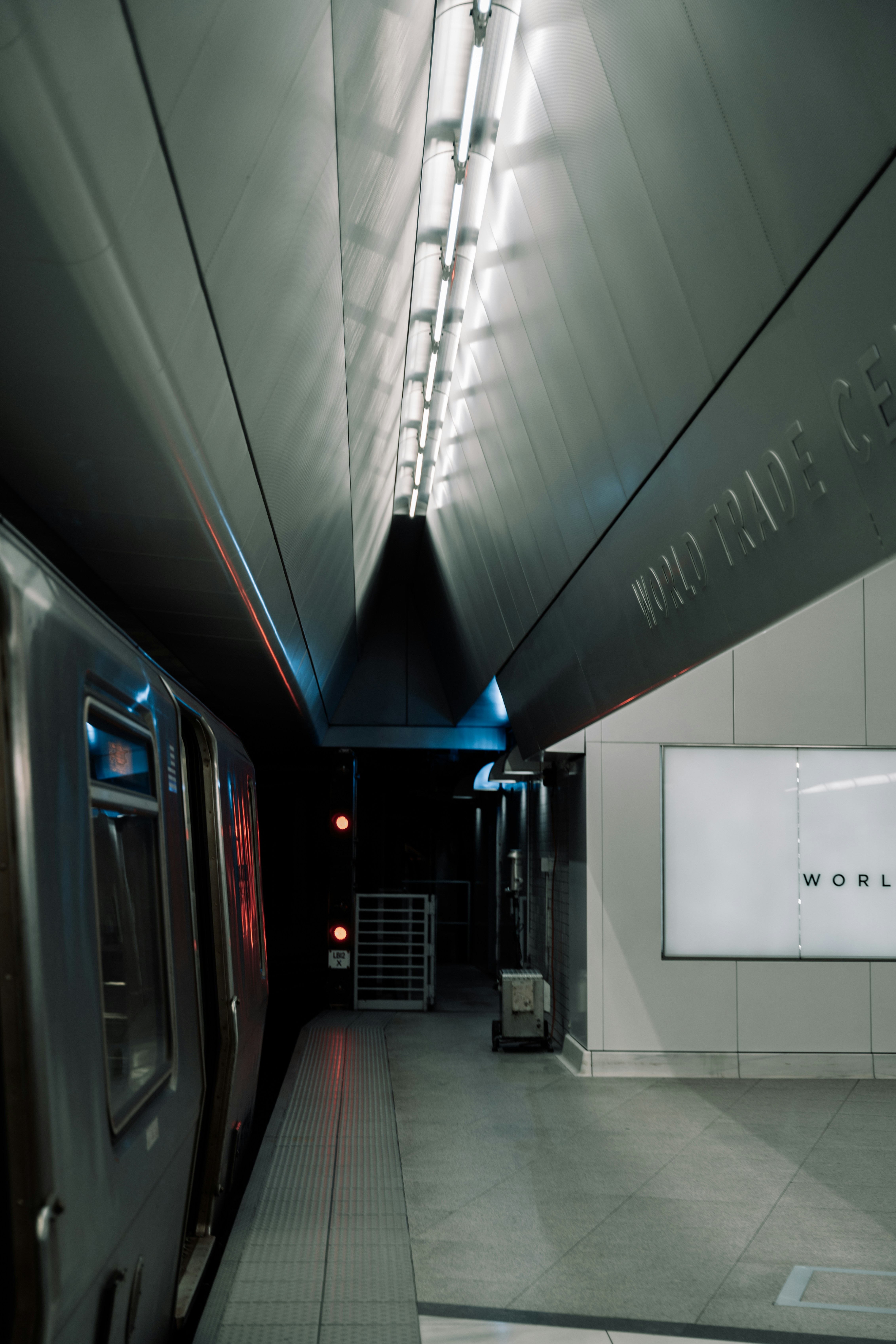 Neon Lines Converge on a Subway Platform Receding into Darkness