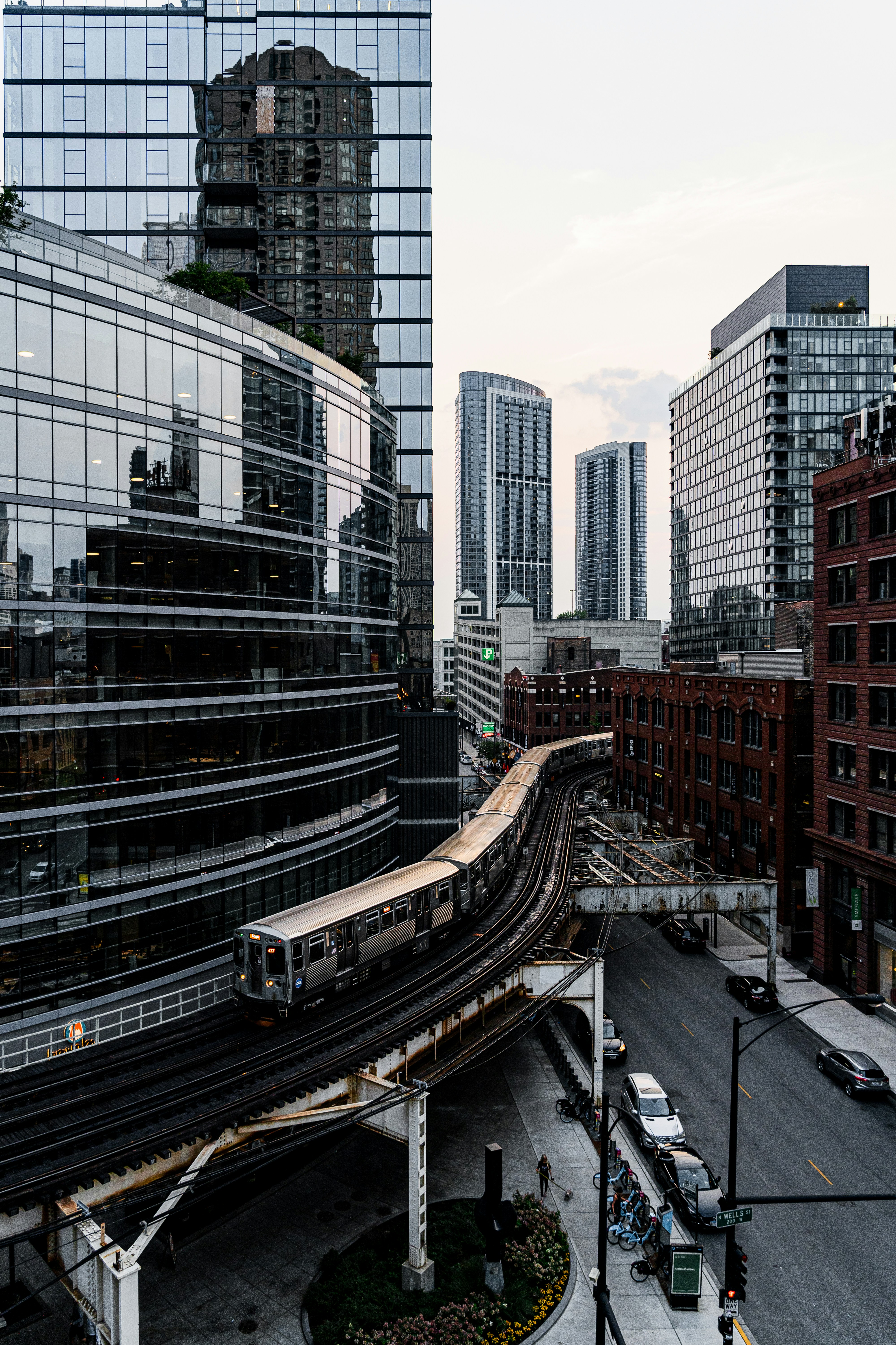 CTA L Train rounding the bend outside of a office building