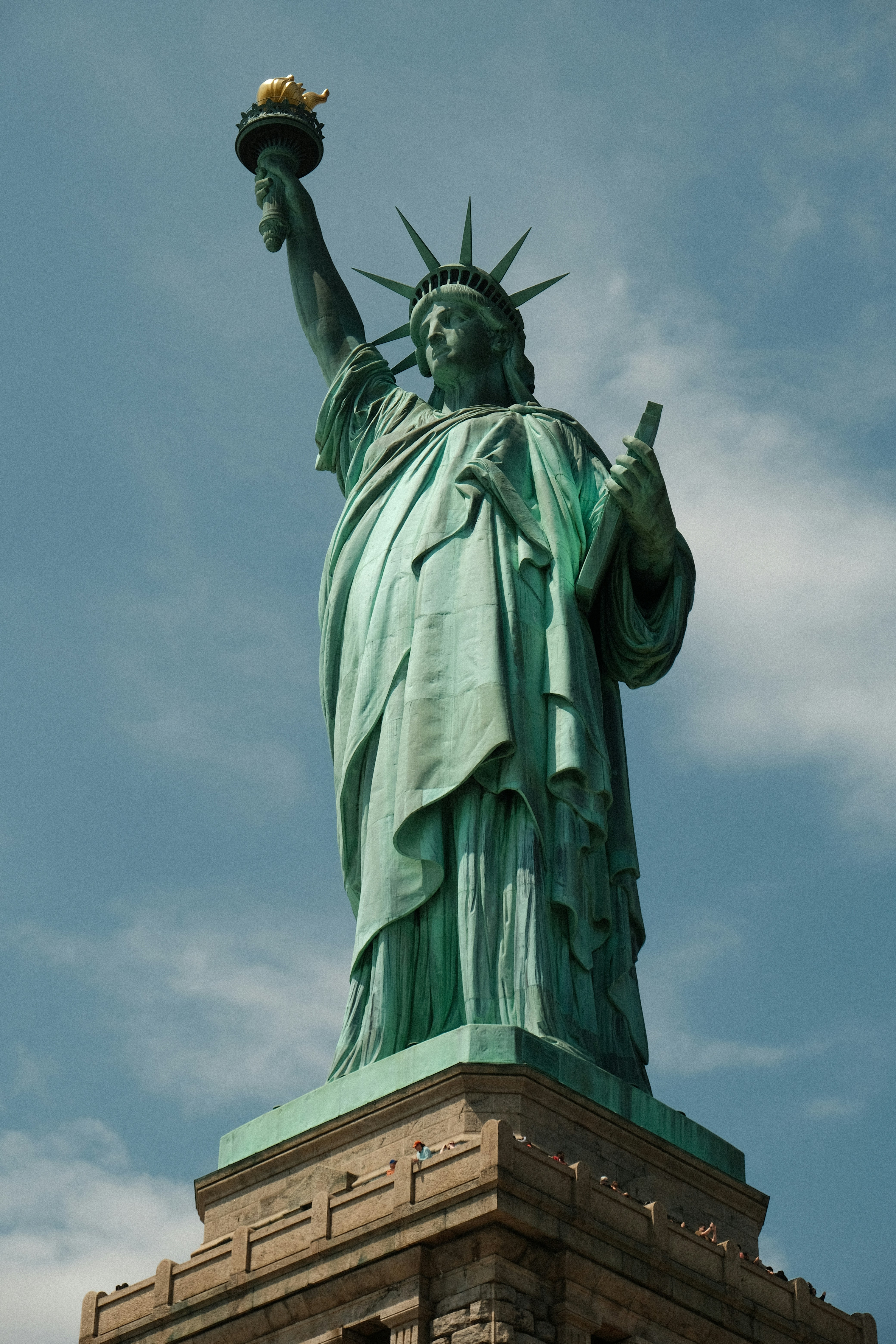 The statue of liberty is shown against a blue sky photo – Free American ...