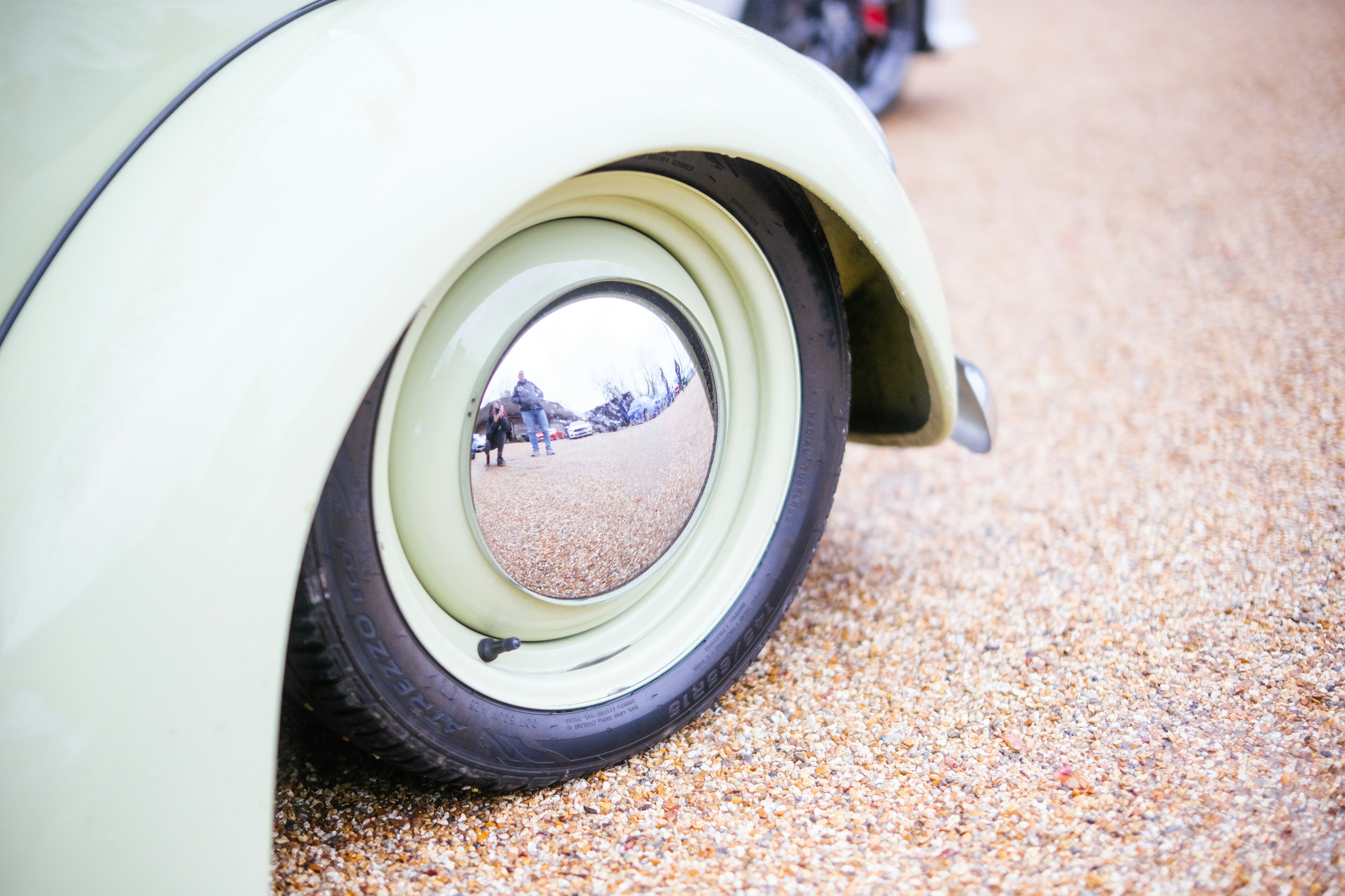 Reflection in a Mint-Green Vintage Wheel on Gravel