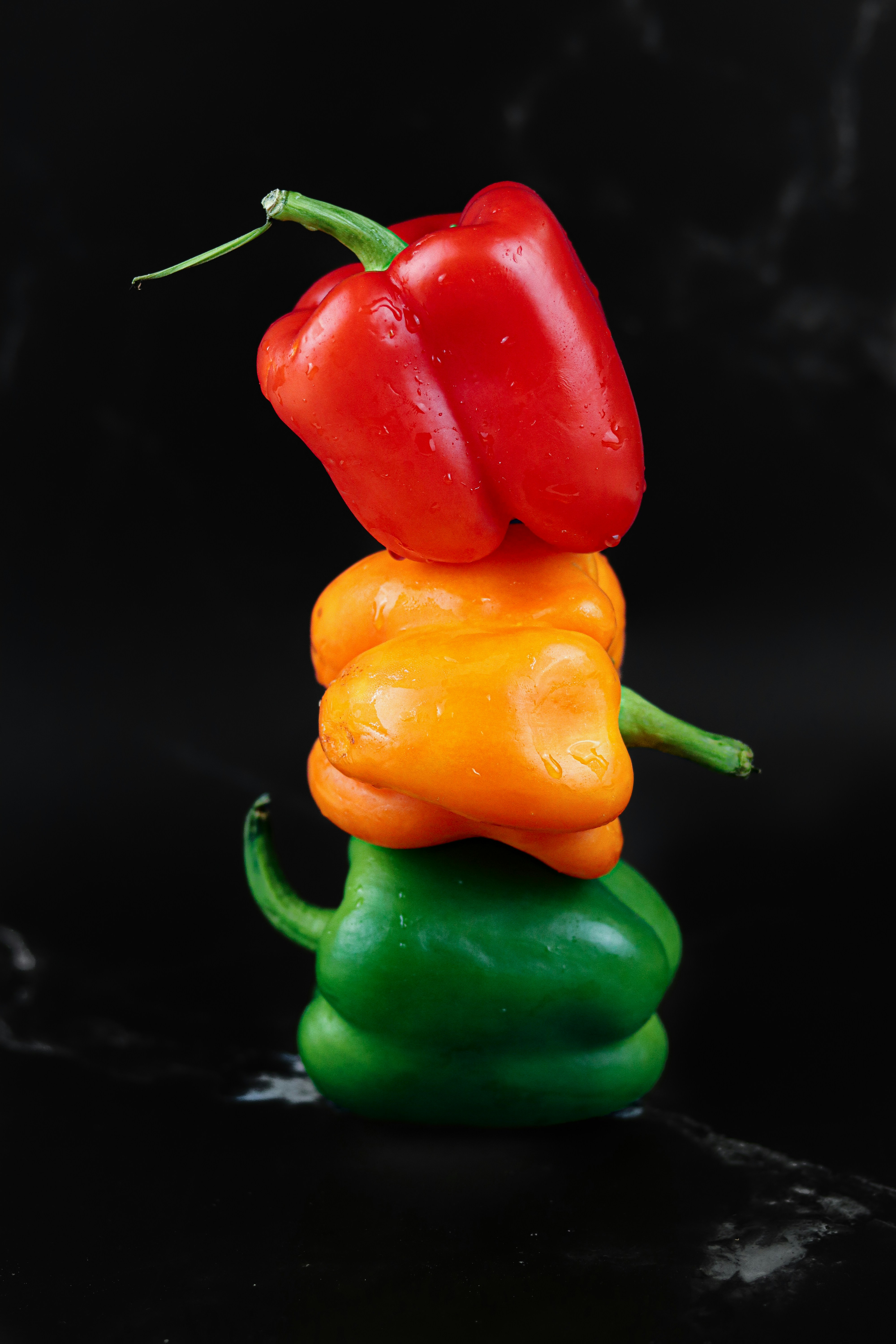 a stack of colorful peppers sitting on top of each other