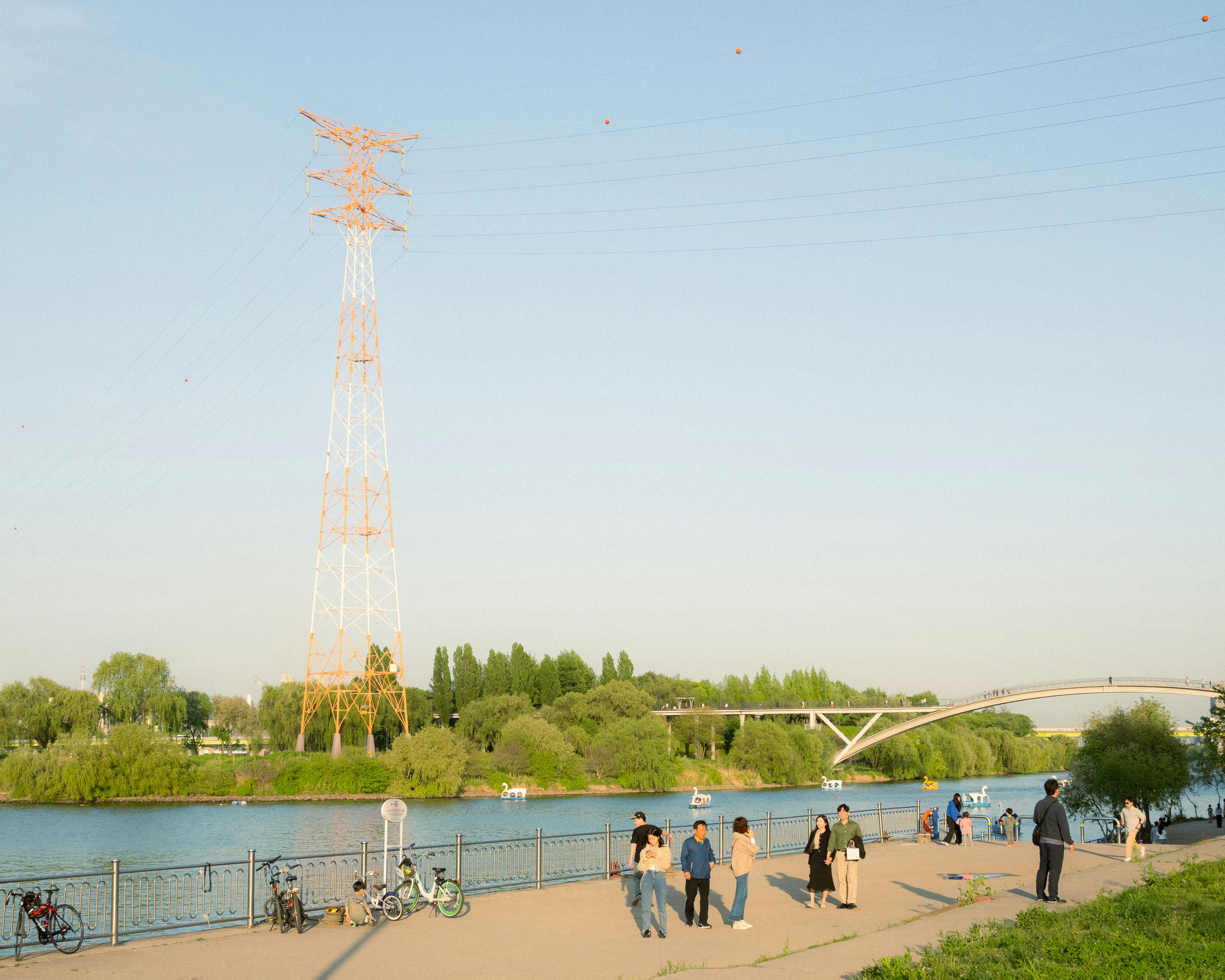 A group of people walking on a path next to a river photo – Free Han ...