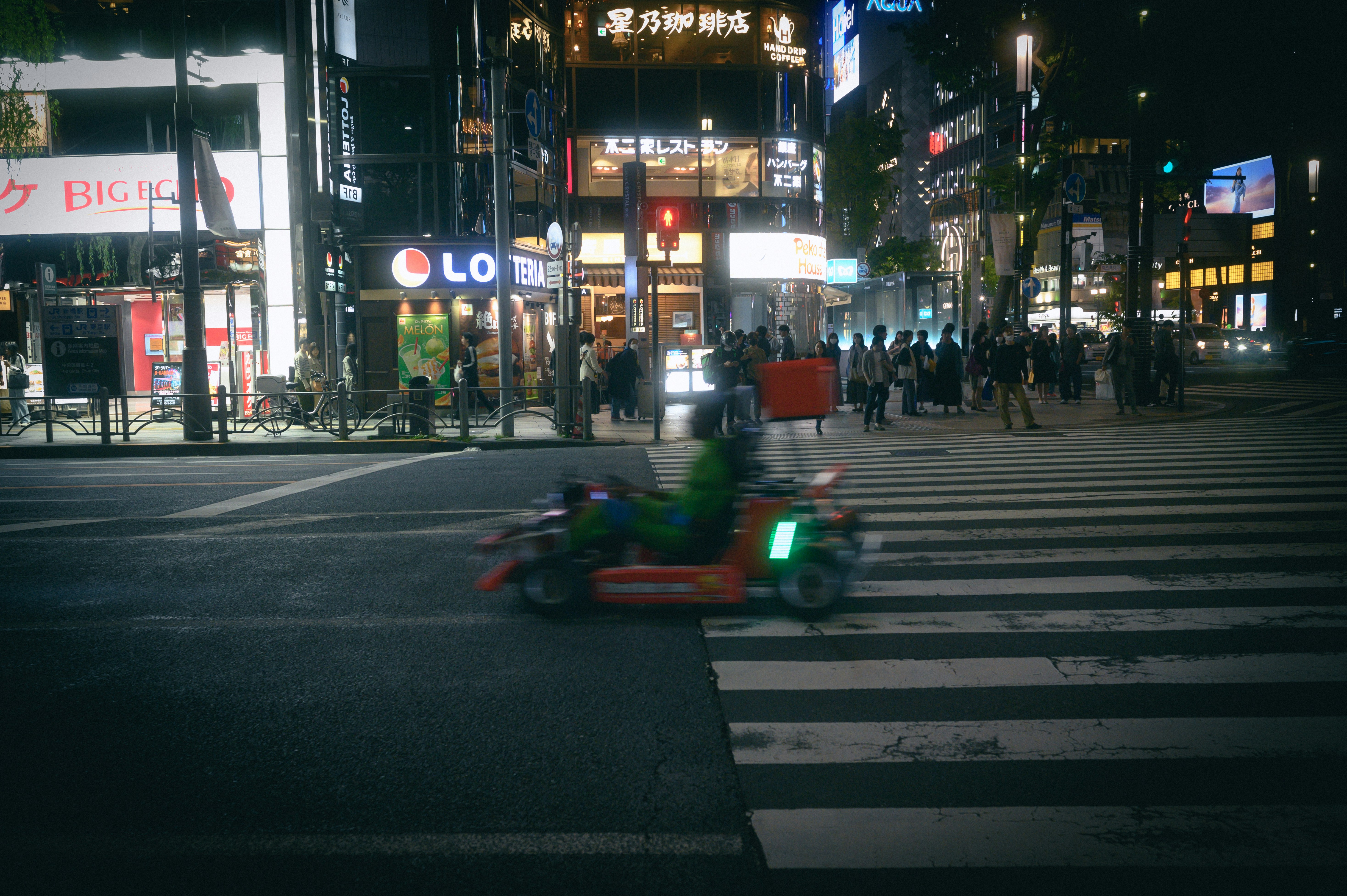 Neon Night Rider: Blurred Motion Across a Neon-Lit City Crosswalk