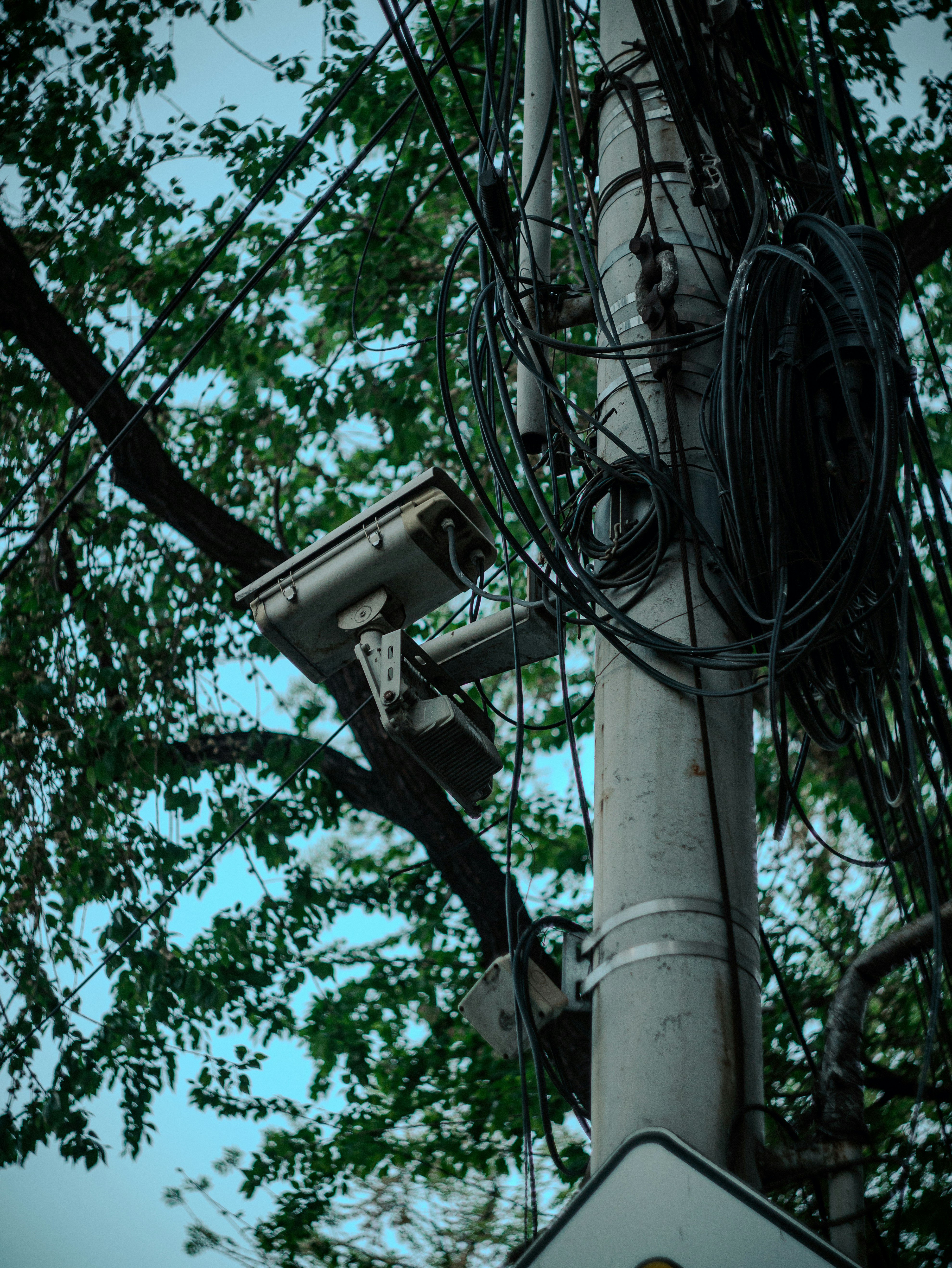 a close up of a street sign with wires on it