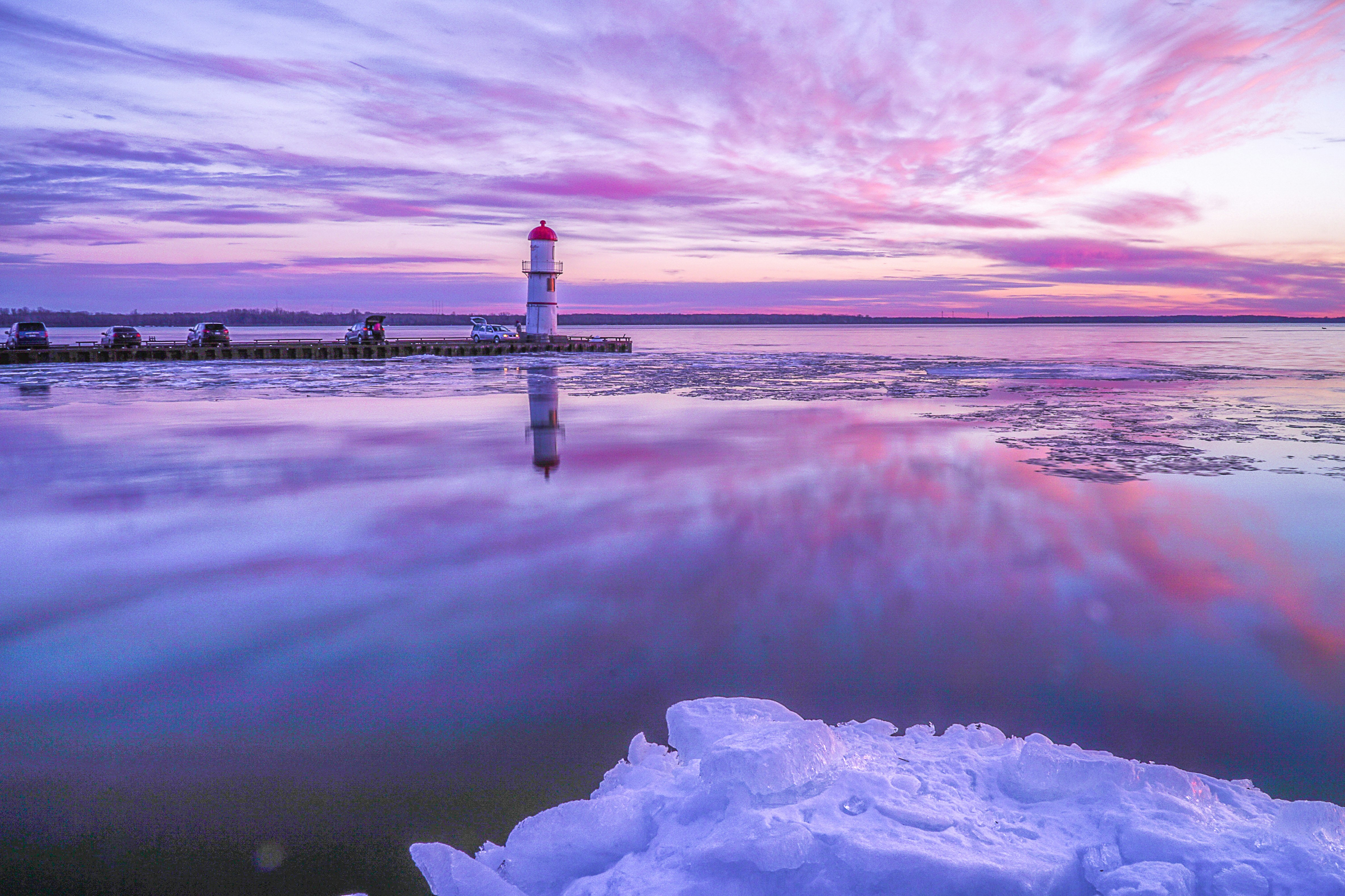 Lighthouse at Dusk: Violet Skies and Icy Reflections
