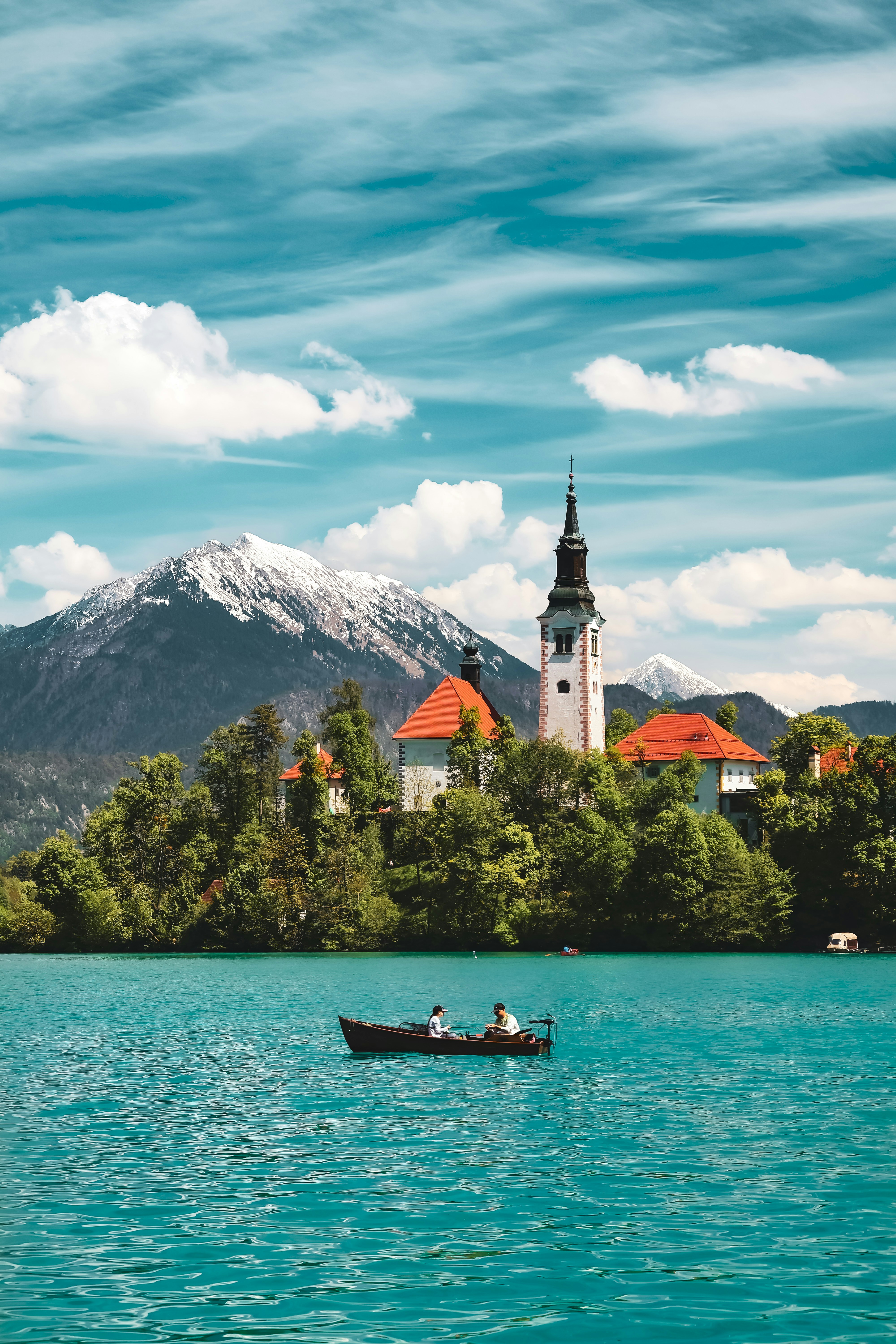 Bled in Spring | a small boat floating on top of a lake