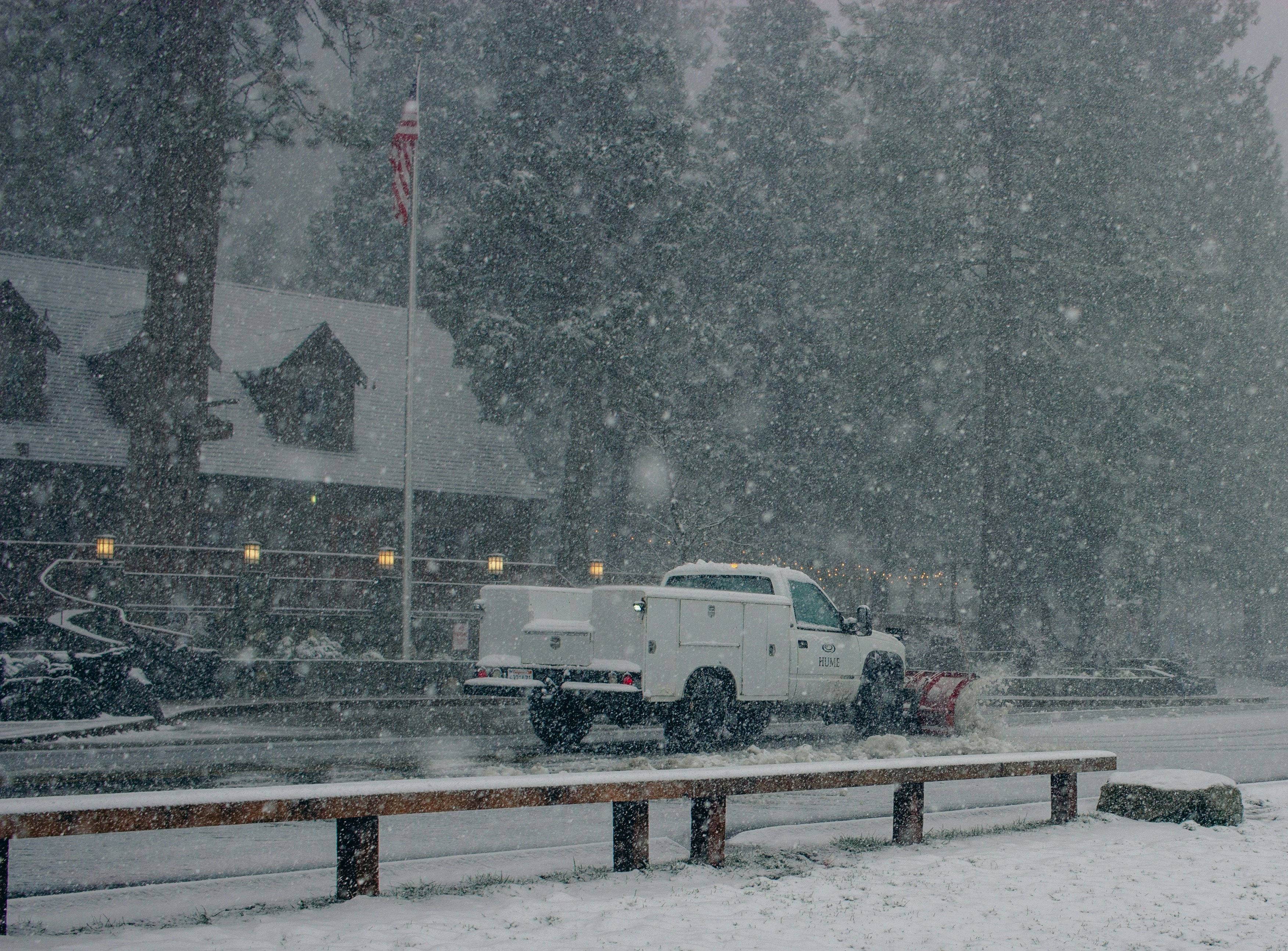 Snowfall on the Riverside Road: A White Pickup in Quiet Drift