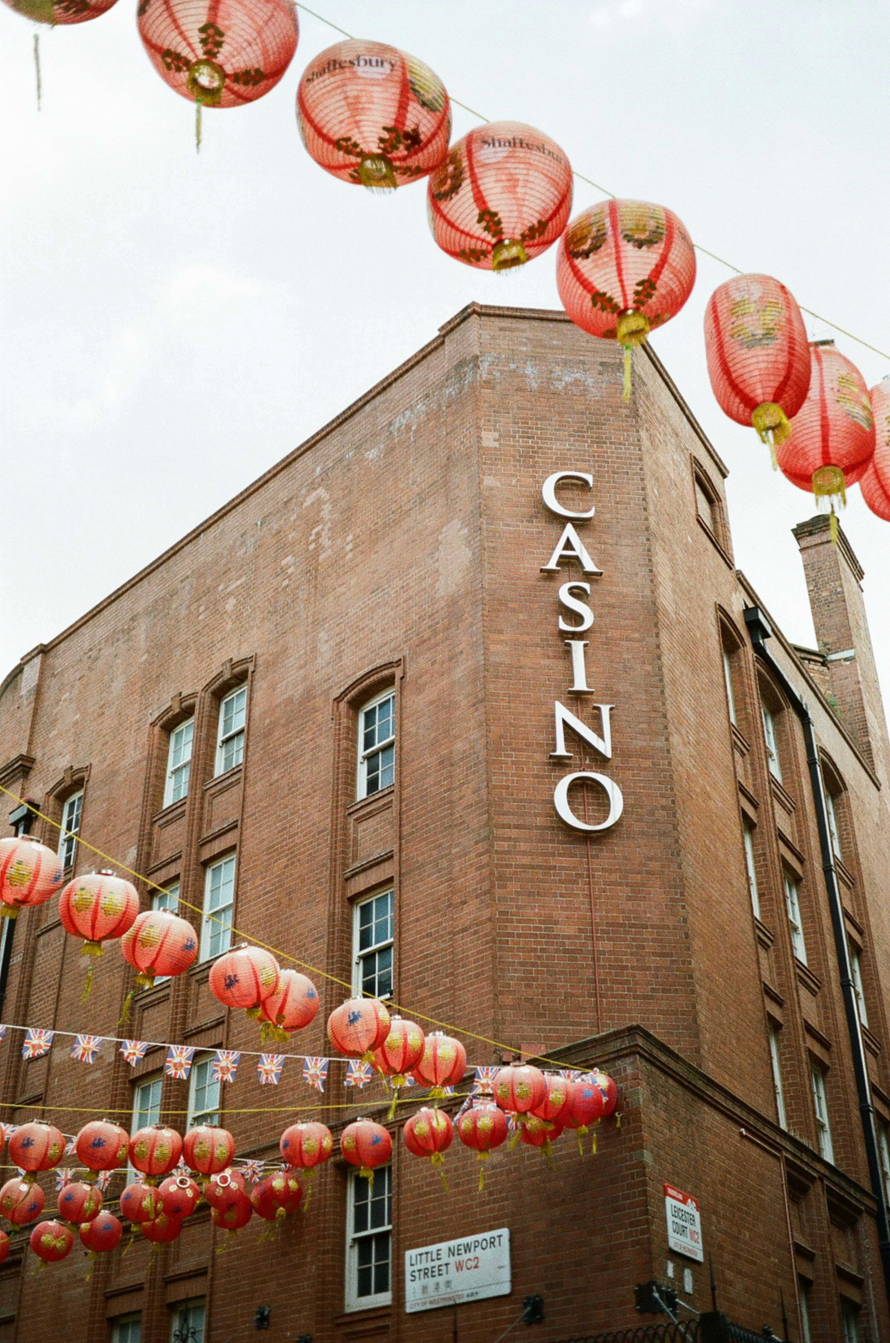 A building with red lanterns hanging from it's side photo – Free London ...