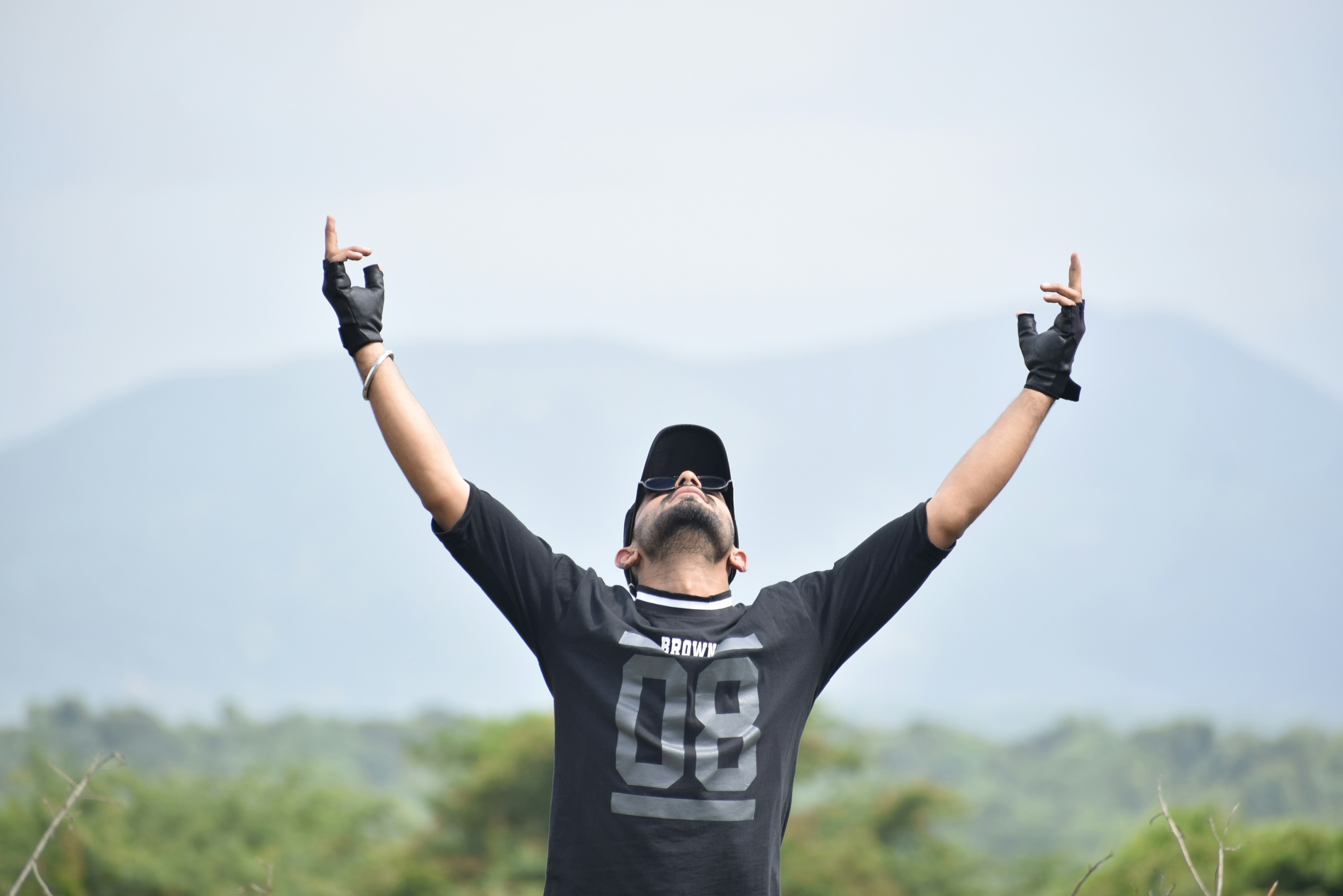 Raised Arms Under a Quiet Mountain Horizon