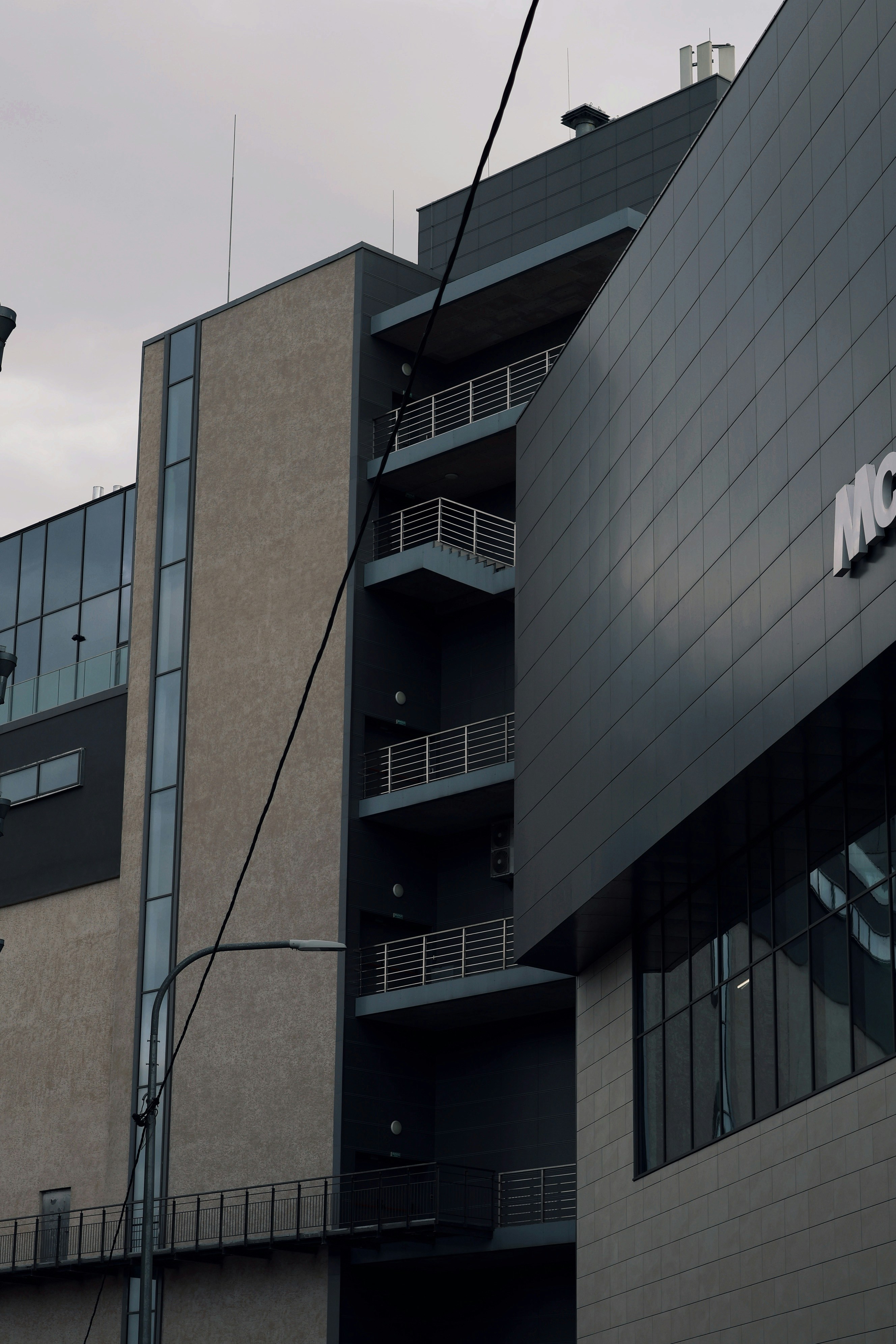 Cantilevered Threads: Vertical Balconies on a Modern Facade