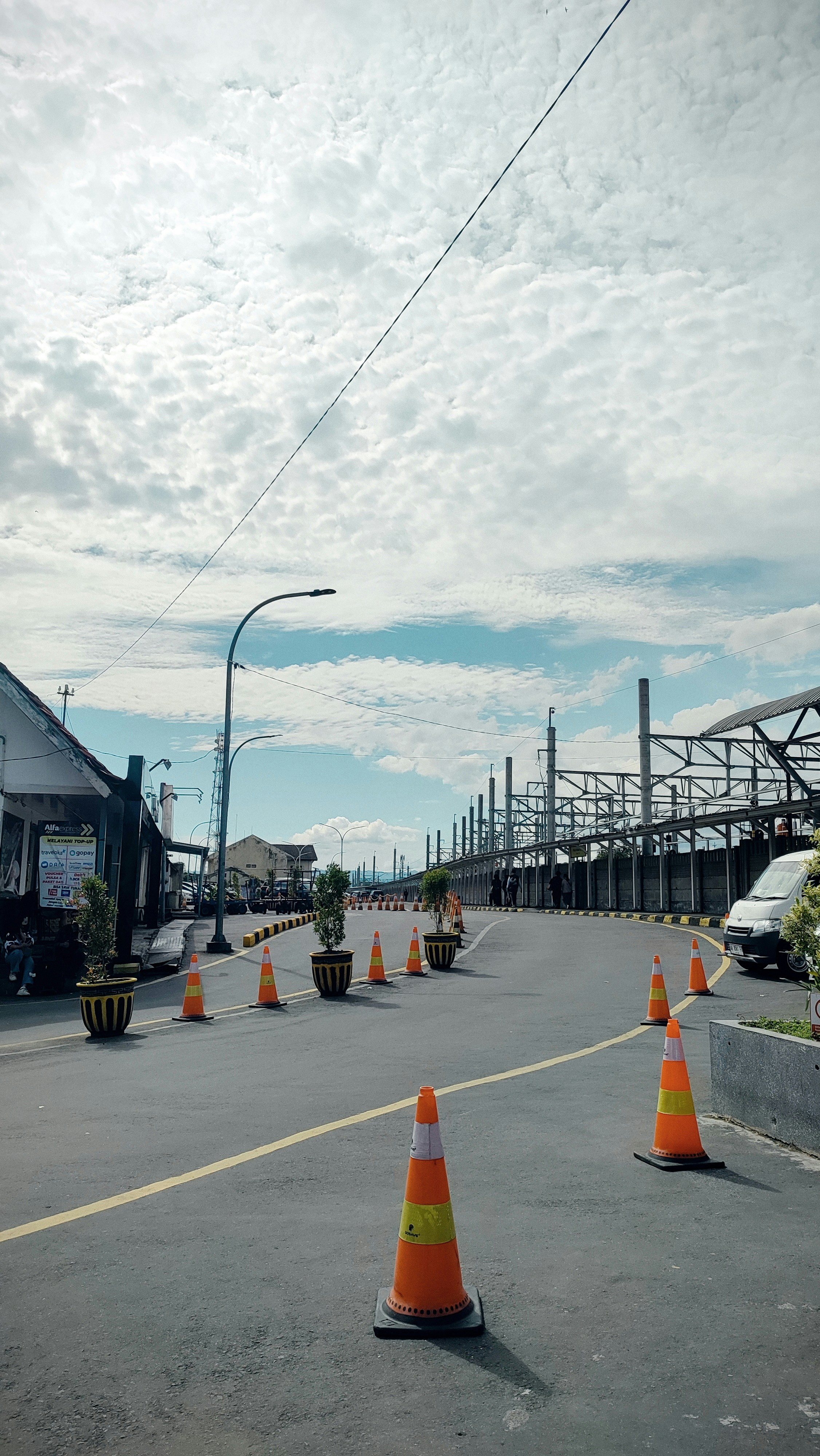 Cones on a Vanishing Street: An Industrial Corridor Under a Soft Sky