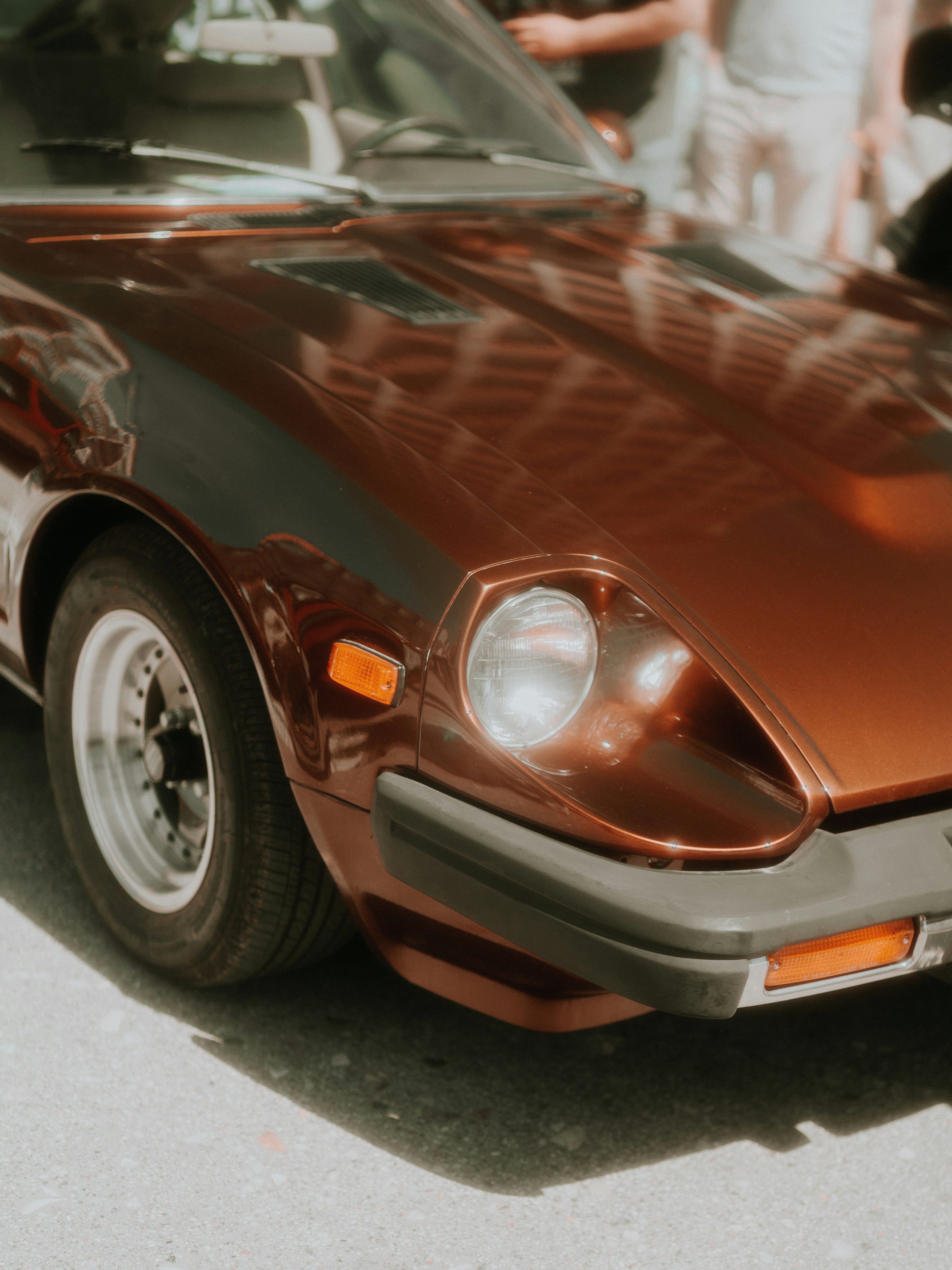 A brown sports car parked in a parking lot photo – Free Classic Image ...