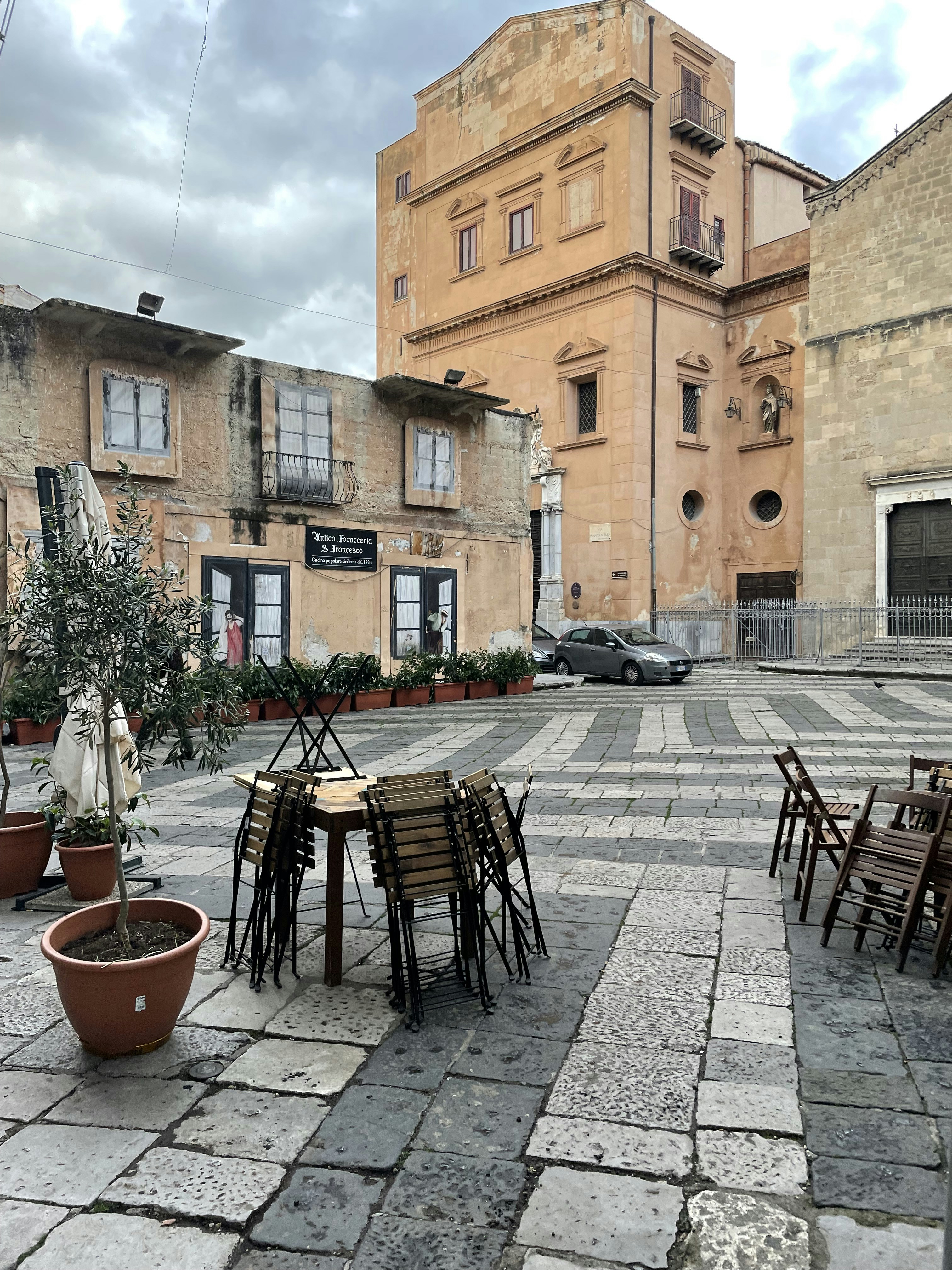 Cobbled Piazza Backdrop: Outdoor Café among Historic Facades