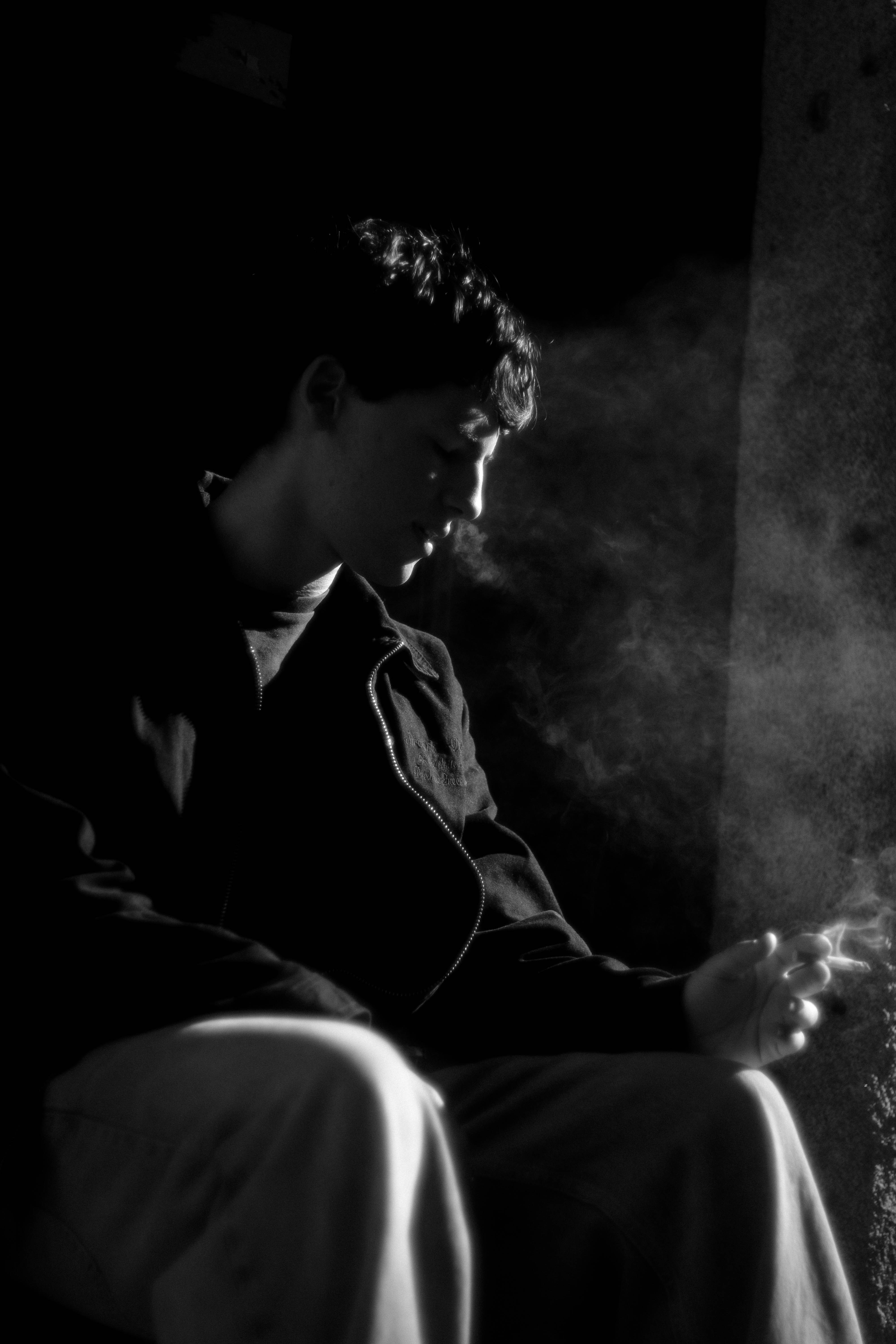 a woman sitting in a chair smoking a cigarettePedro Vieira