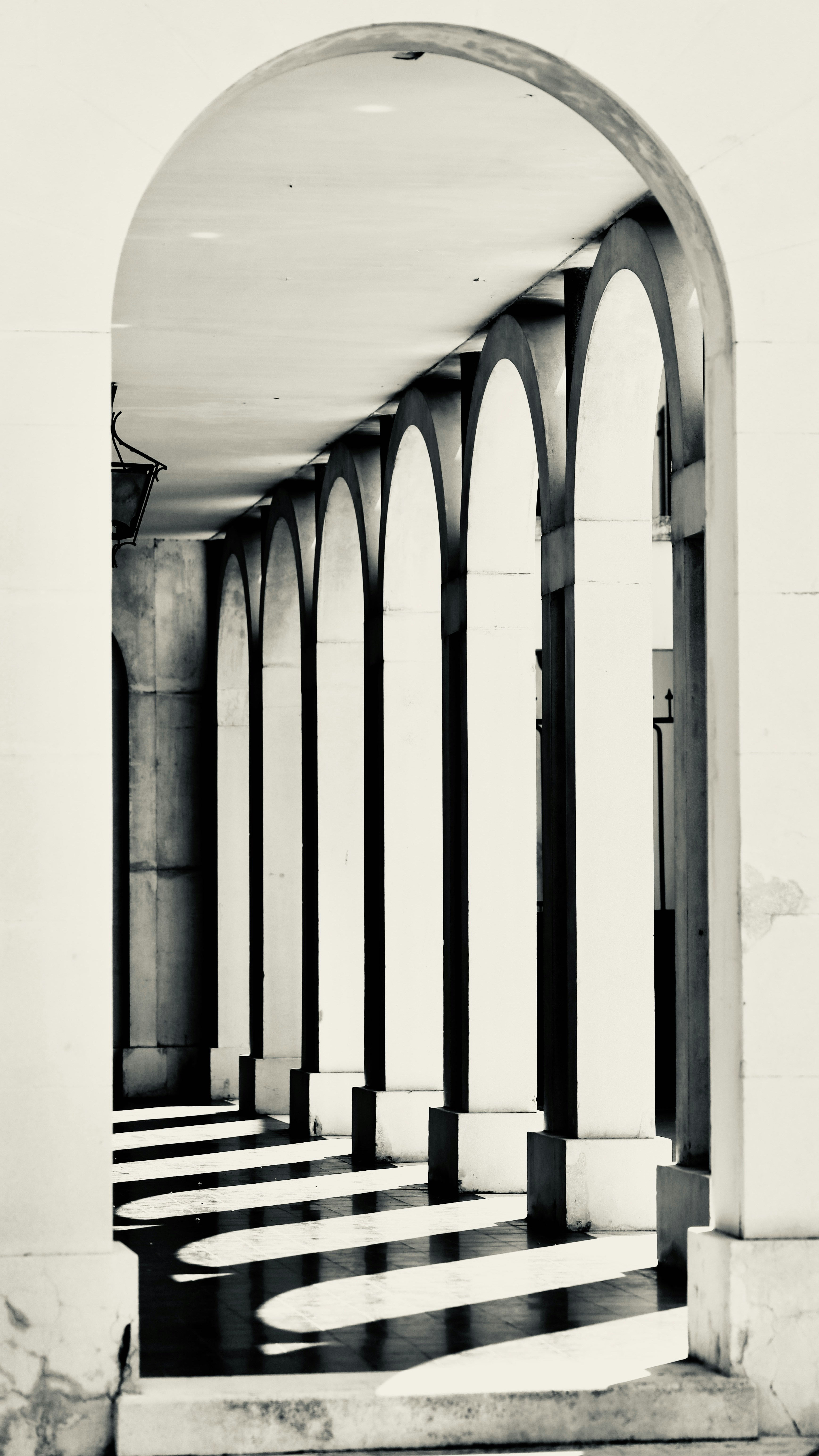 Monochrome Arcades: Receding Arches and Intersecting Shadows