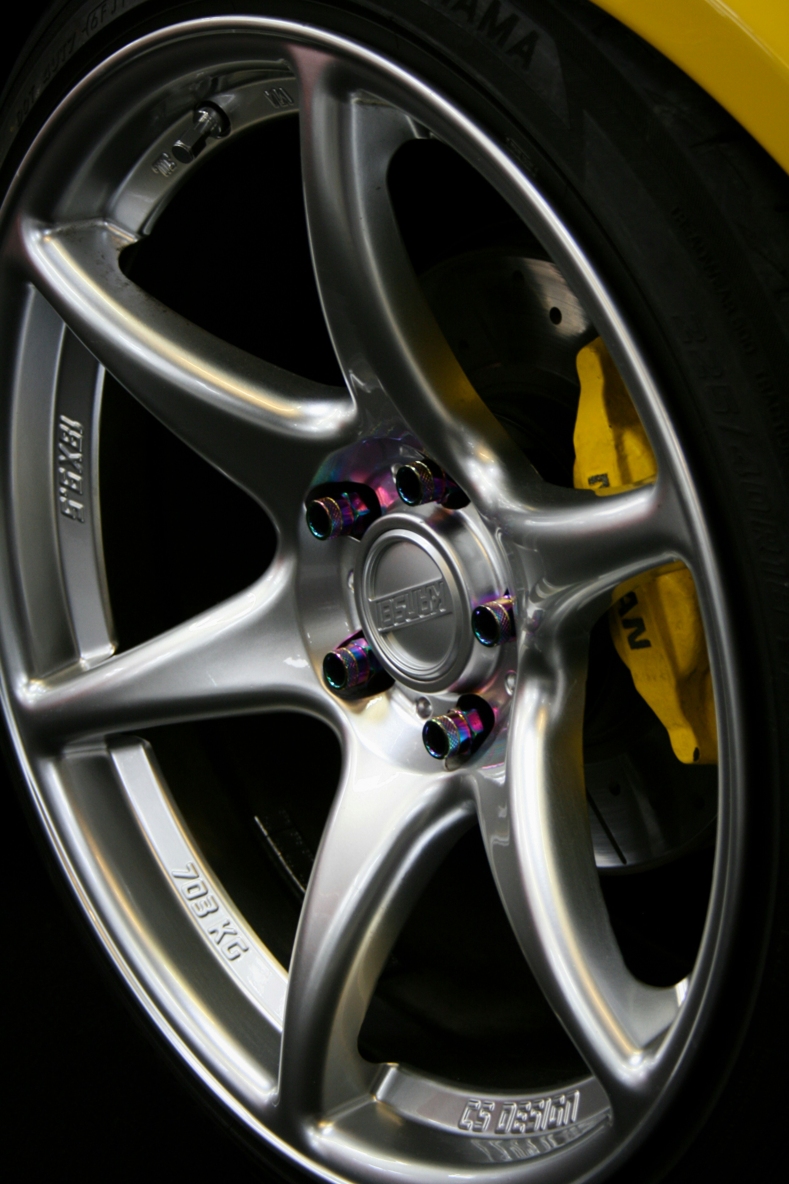 Chromed Precision: Close-Up of a Five-Spoke Alloy Wheel with Neon-Yellow Calipers