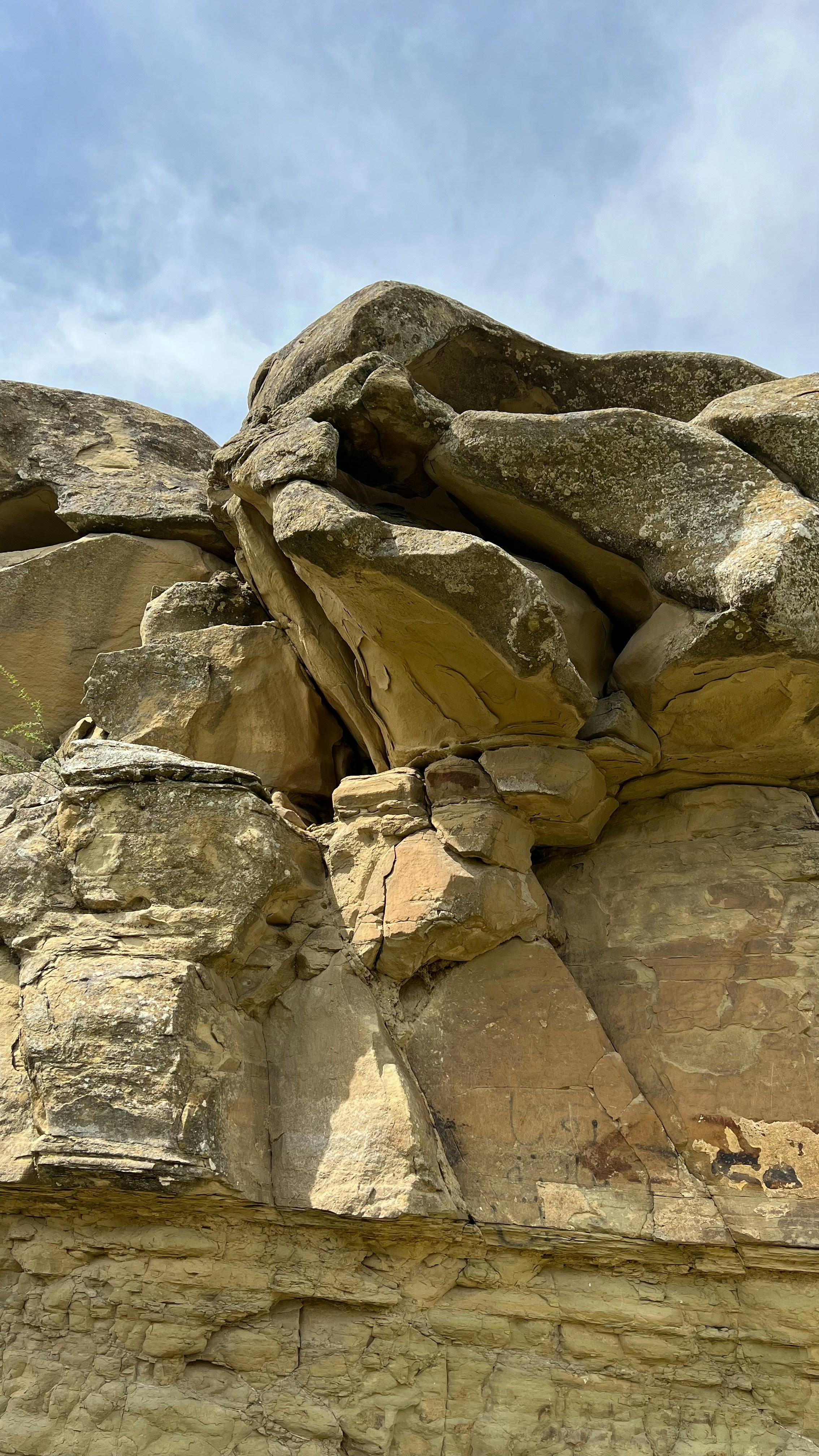 Time-Sculpted Overhang: Weathered Sandstone Shapes Against a Clear Sky