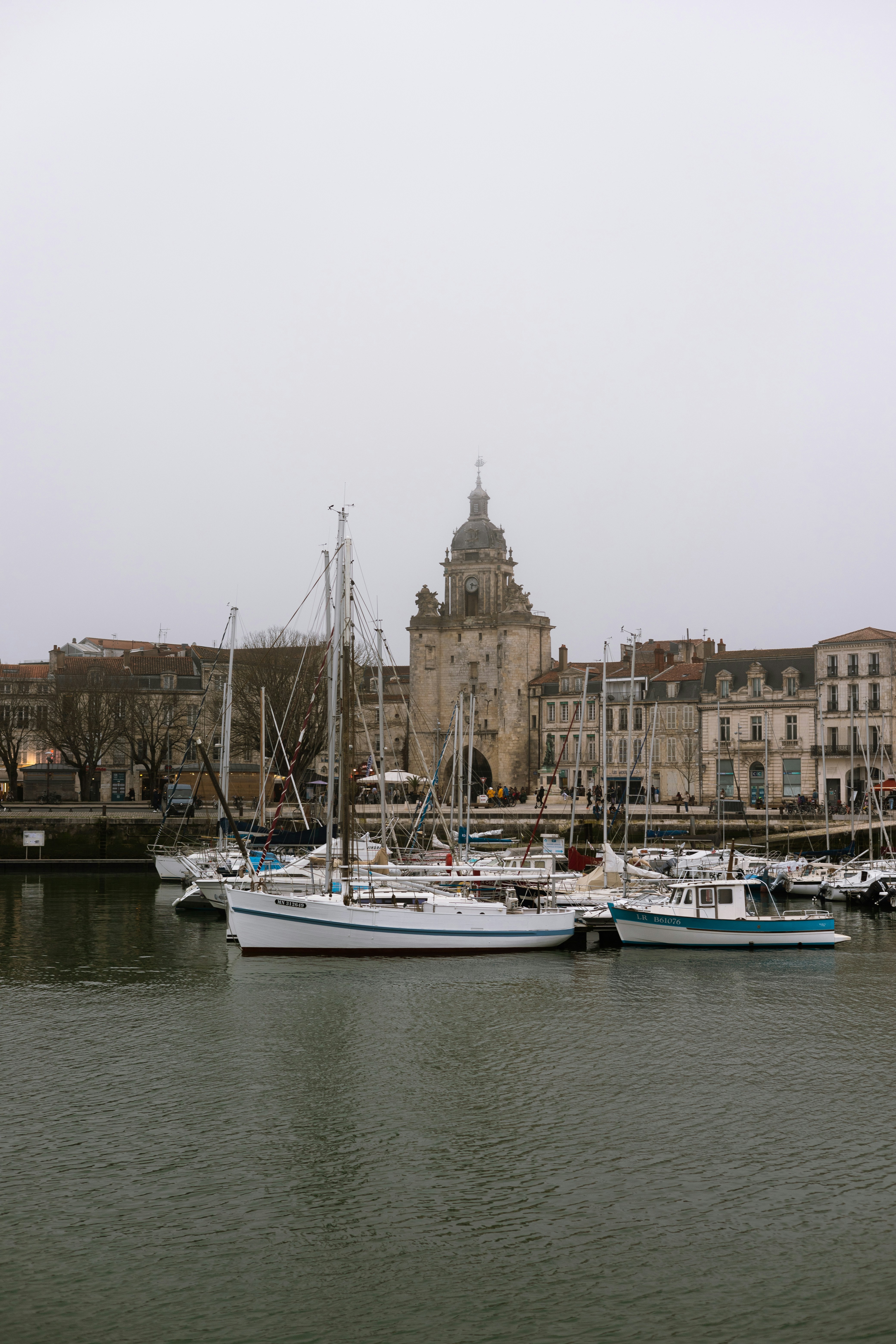 Quiet Harbor: Masts Framing a Century-Old Gatehouse Clocktower