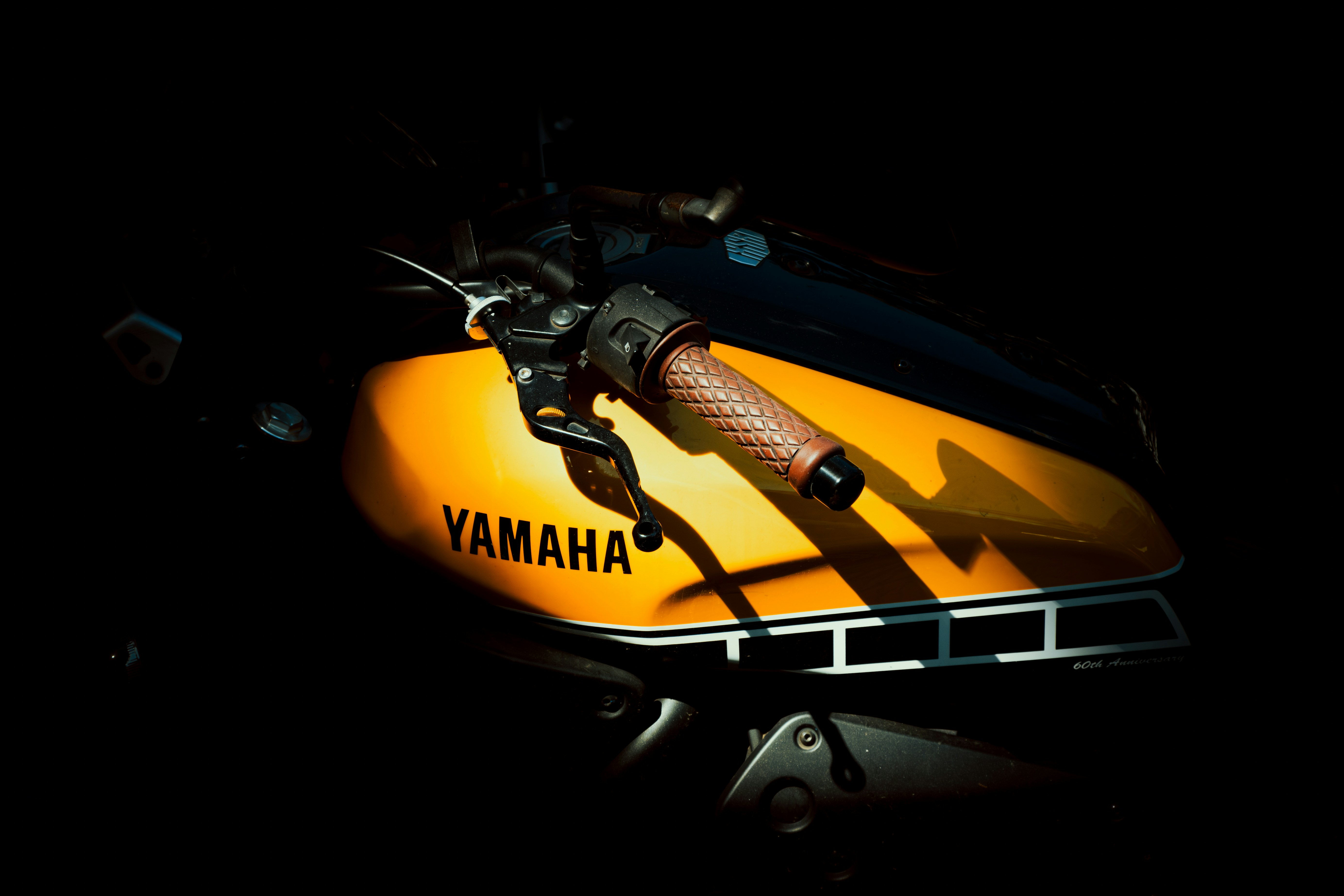 Glint on the Yamaha Orange Tank: A Night-Lit Focus