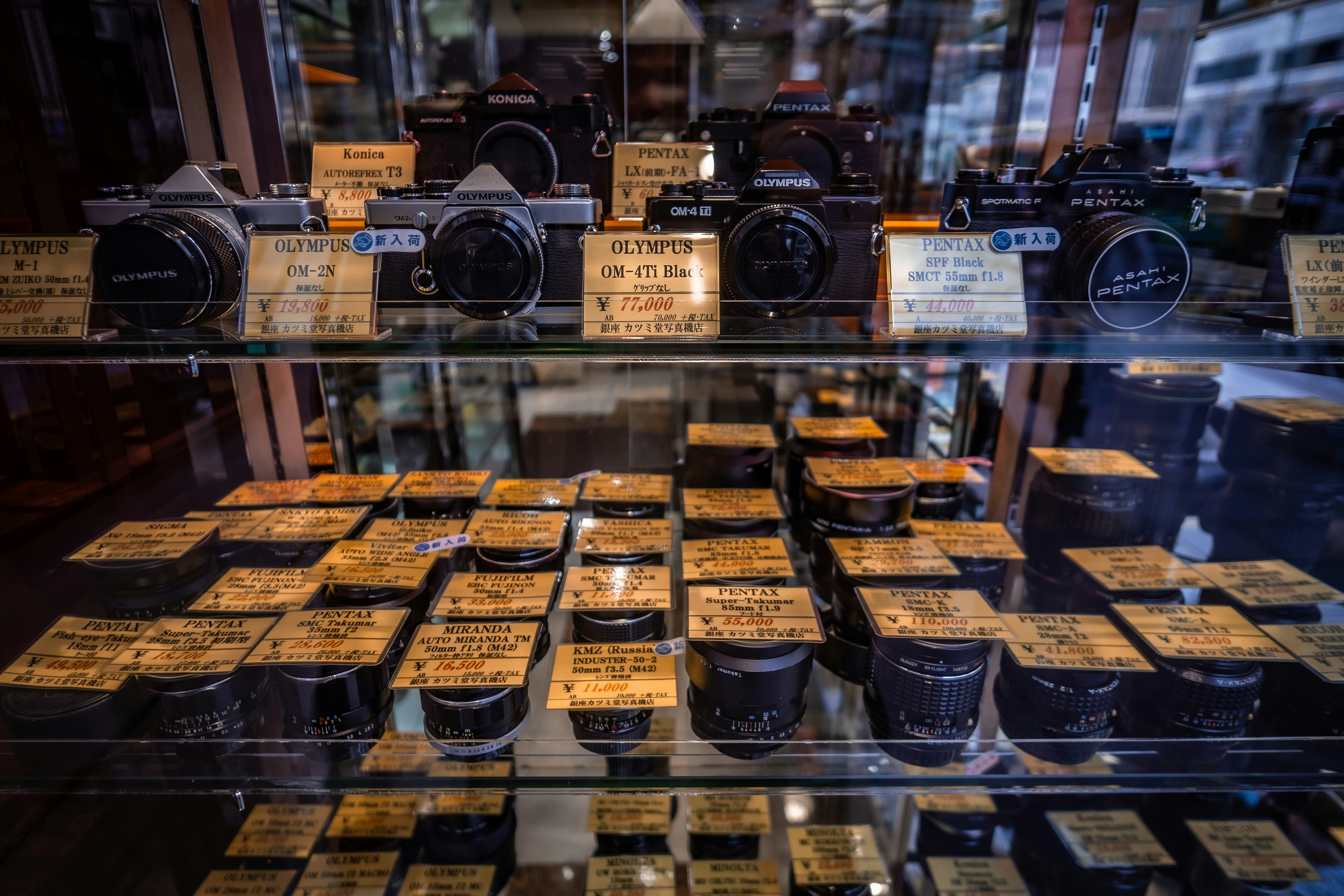A display case filled with lots of different types of cameras photo ...