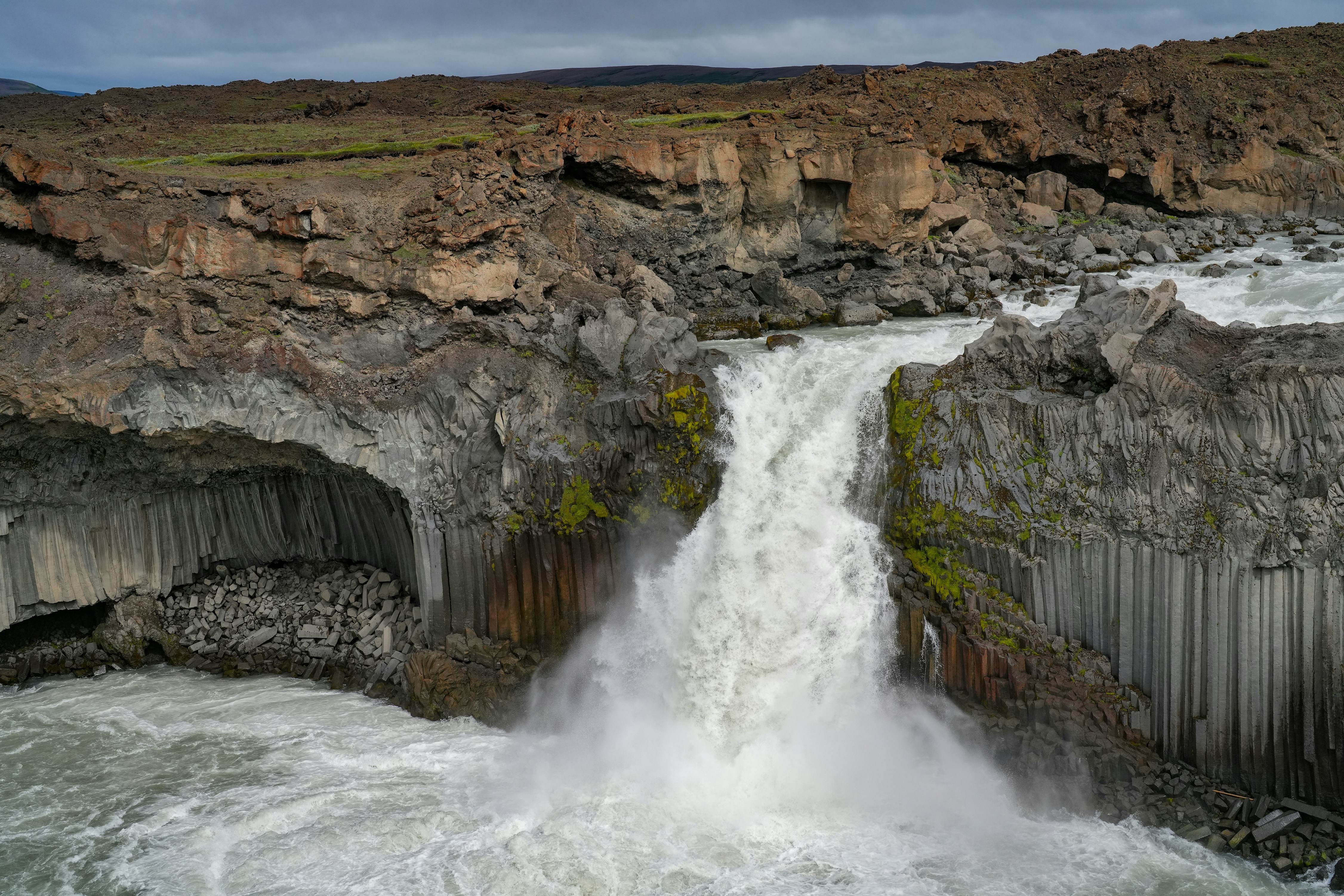 White Curtain Falls Through Basalt Columns in a Rugged Gorge