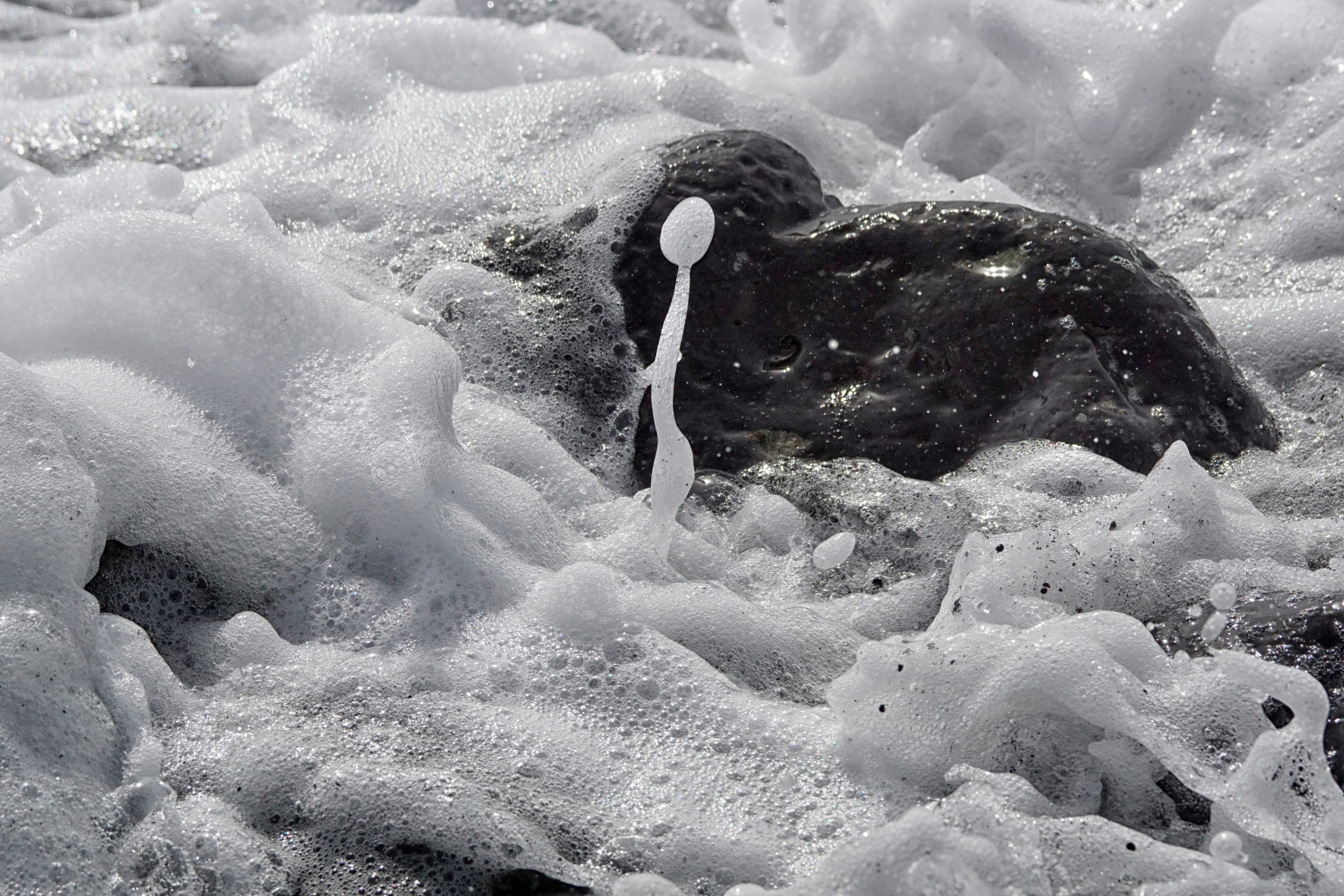 Foam-veiled Break near the Quiet Rock