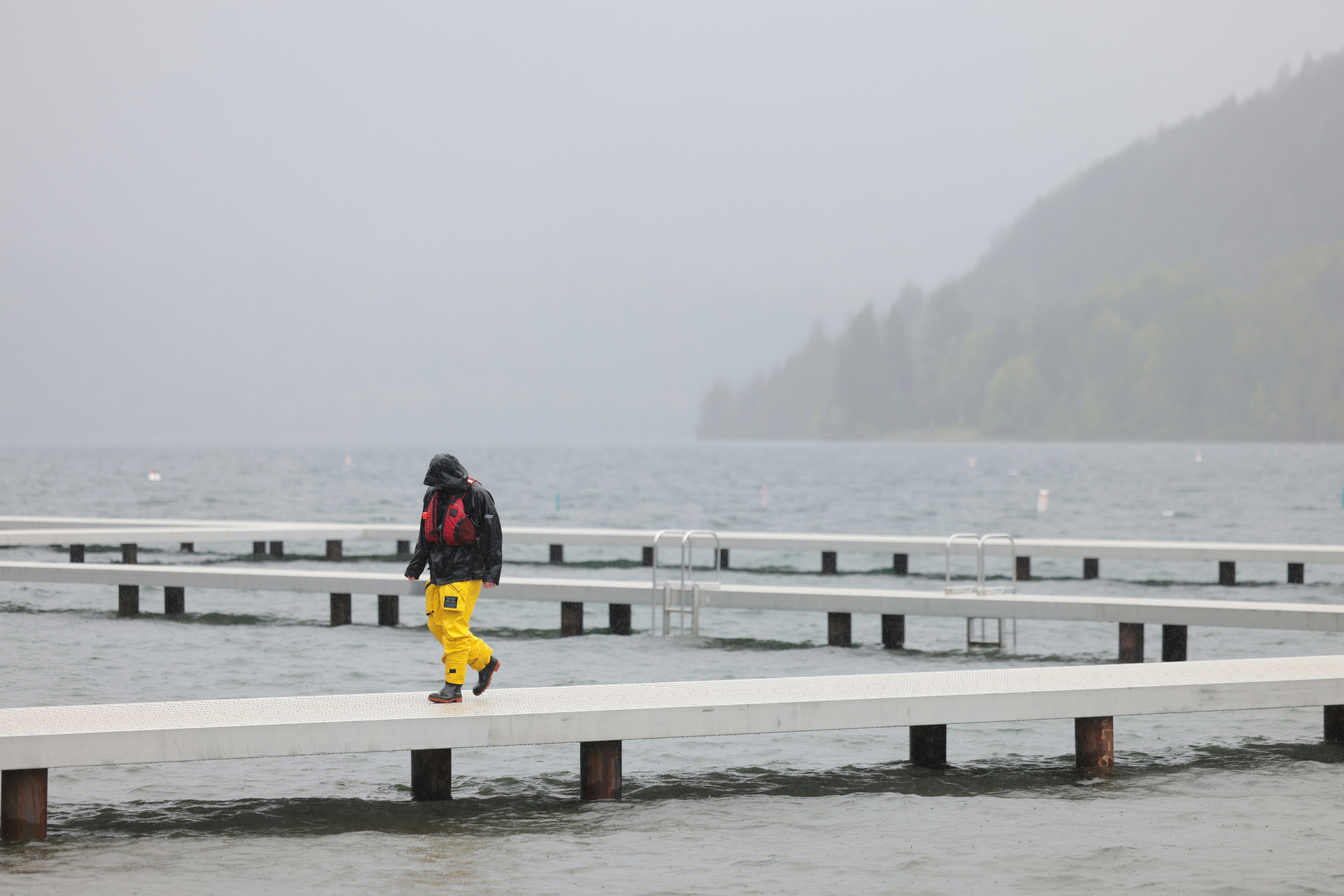 A person walking on a dock in the rain photo – Free Cultus lake Image ...