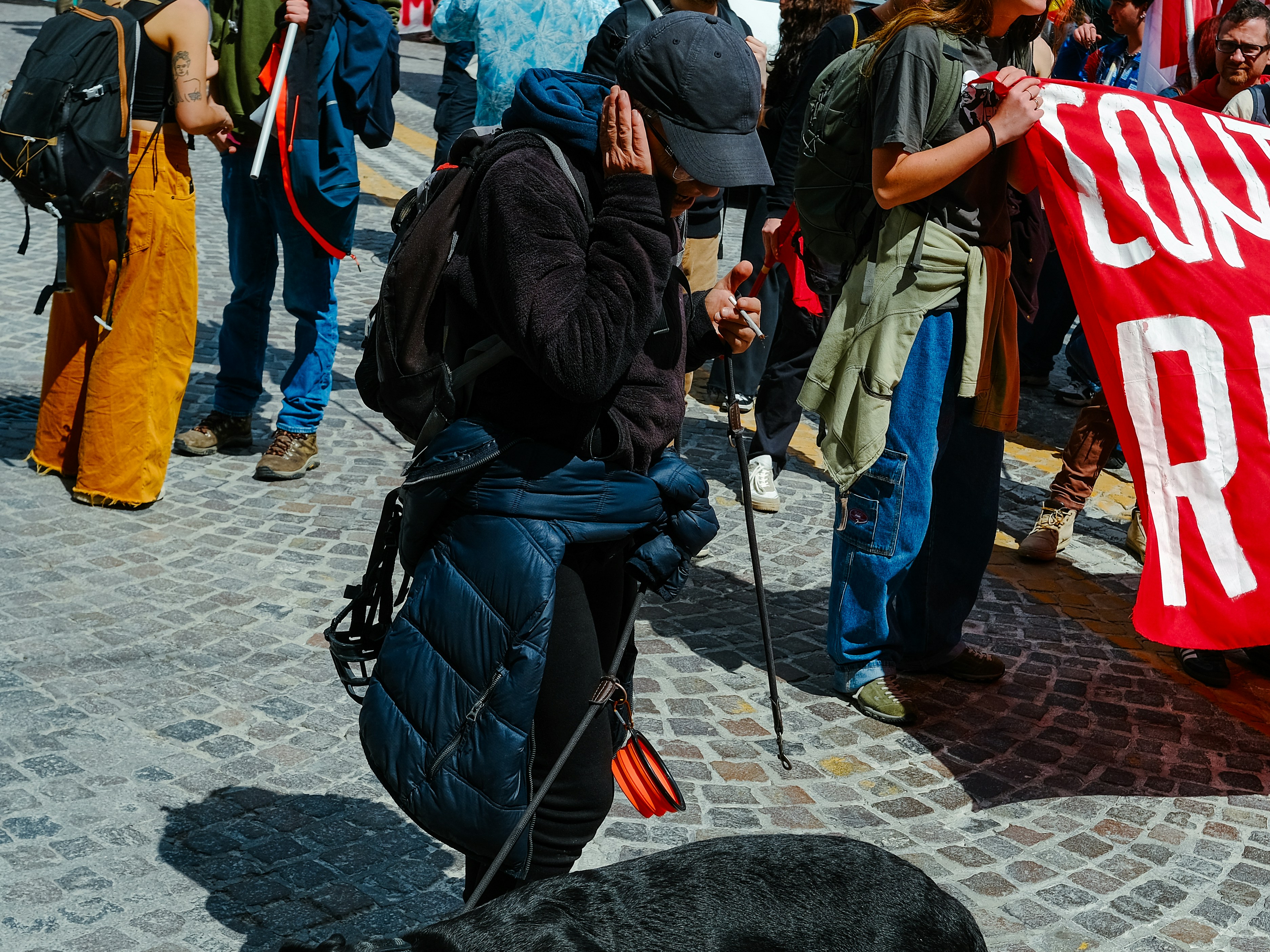 People gathered with a banner in a lively street protest.