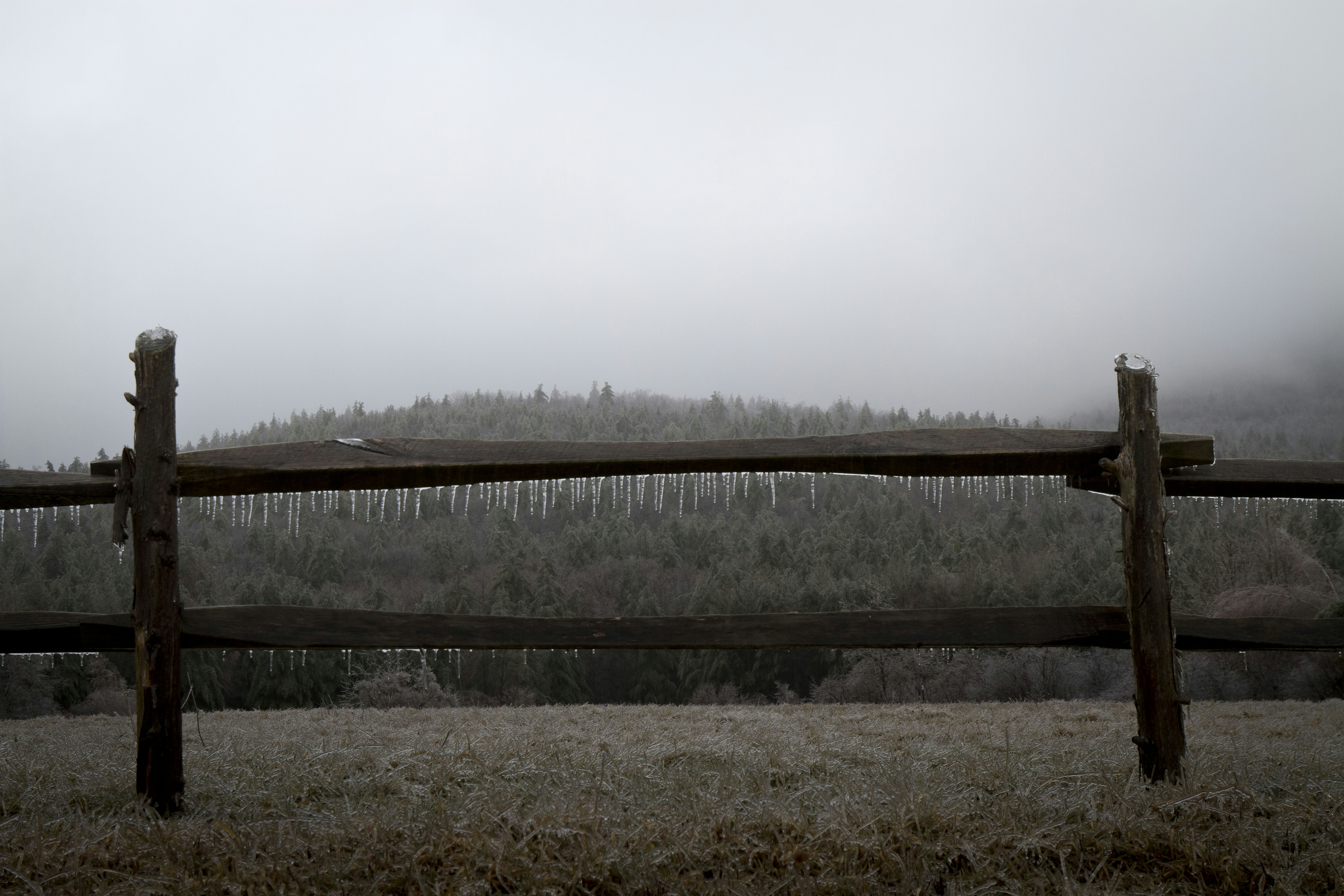 Ridge in the Mist: a Weathered Fence Framing a Quiet Valley