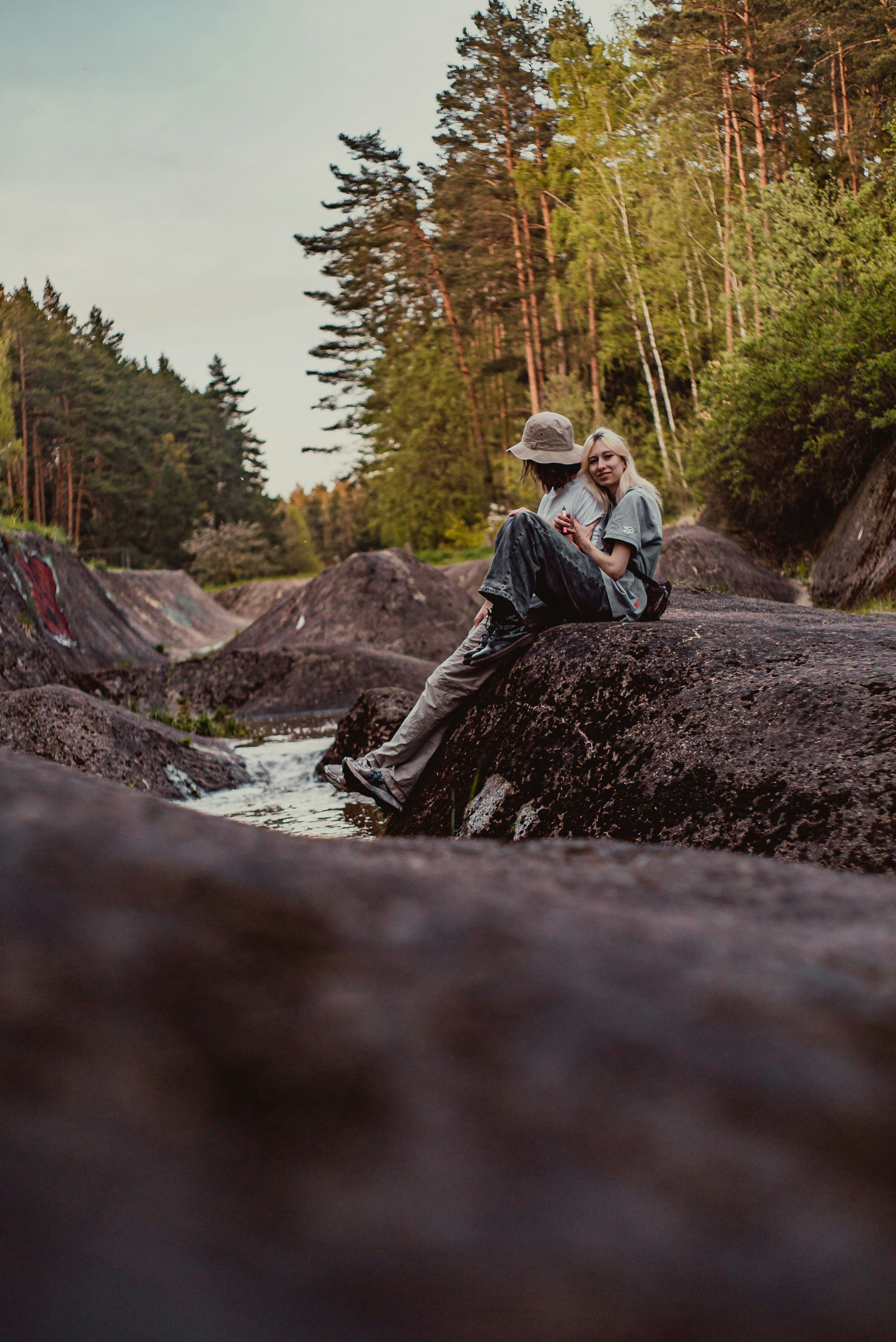 Couple on the Rock: Quiet Moment by the Stream
