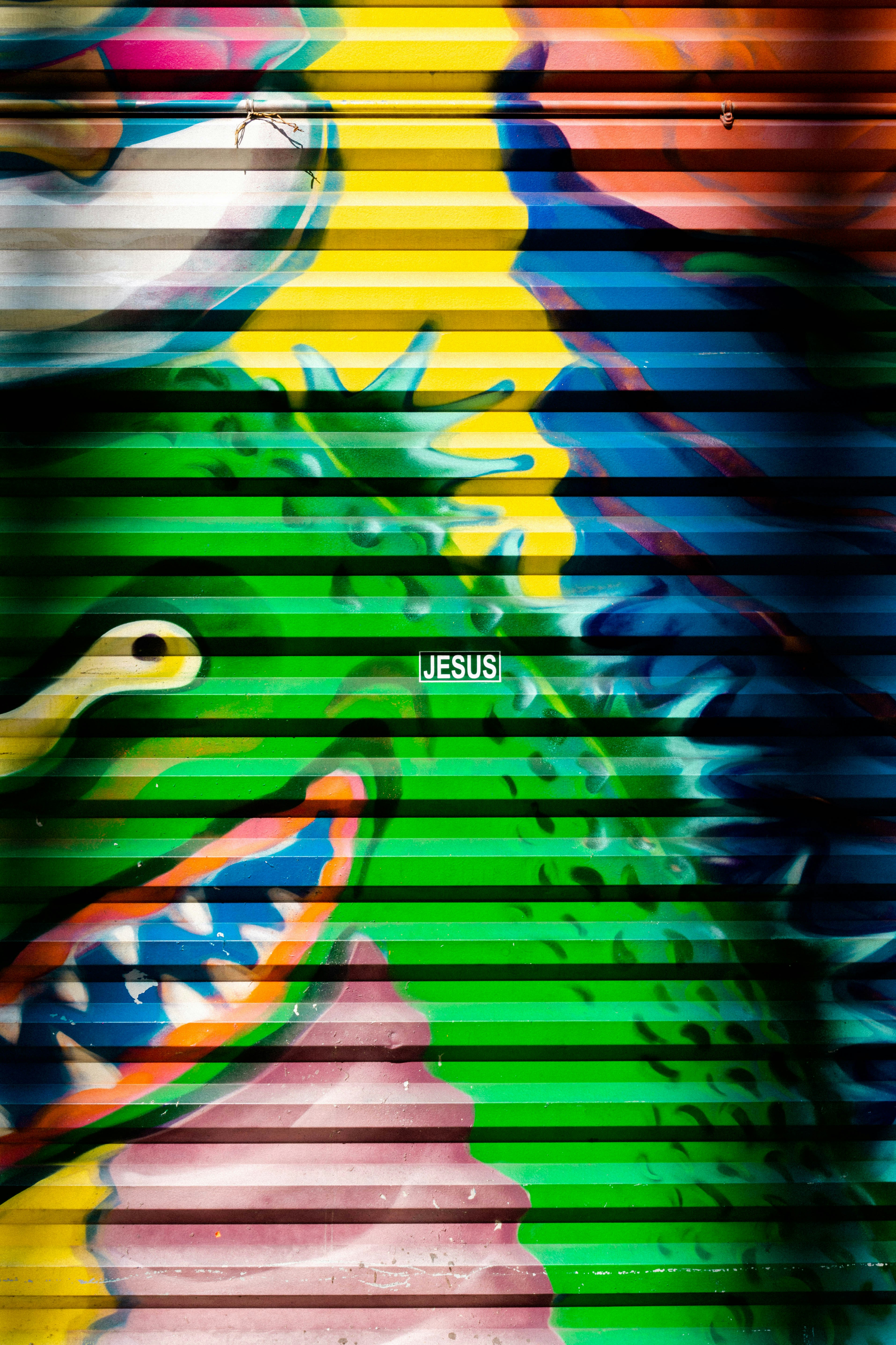 JESUS in Neon Scales: Graffiti Portrait on a Corrugated Door