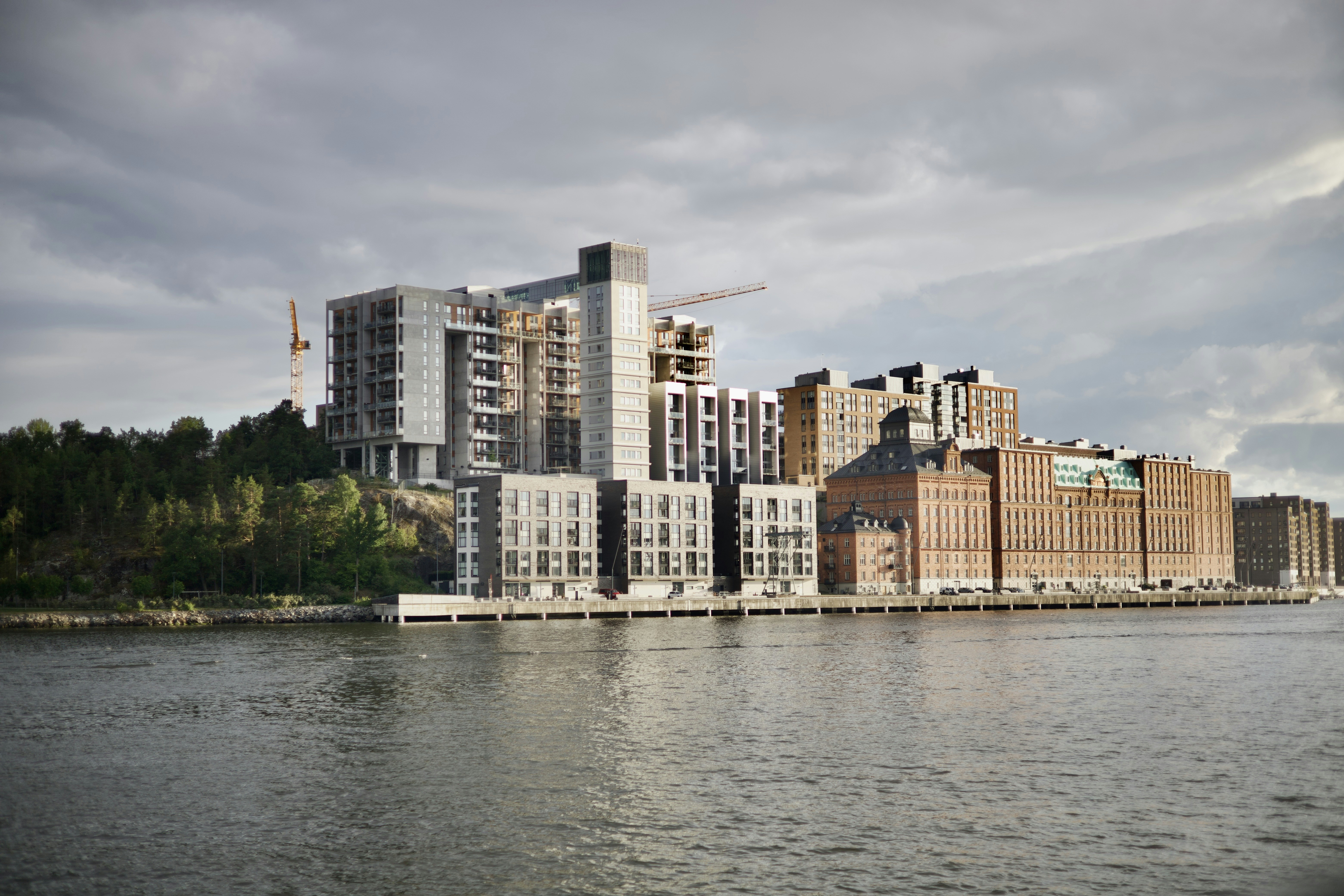 Buildings by the sea in Sweden. | a large body of water with buildings in the background