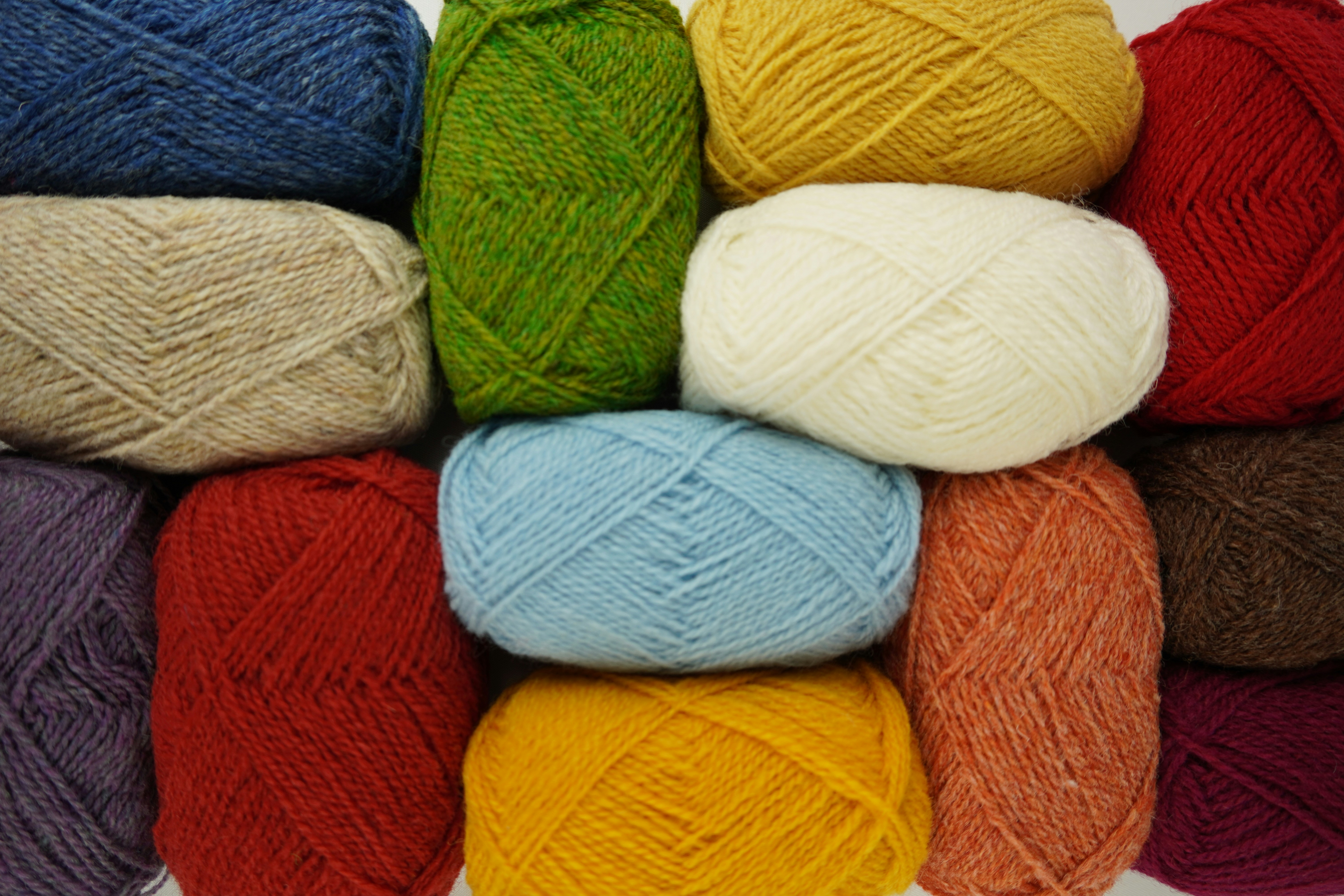 A bunch of balls of yarn sitting on top of each other photo – Free Wool ...
