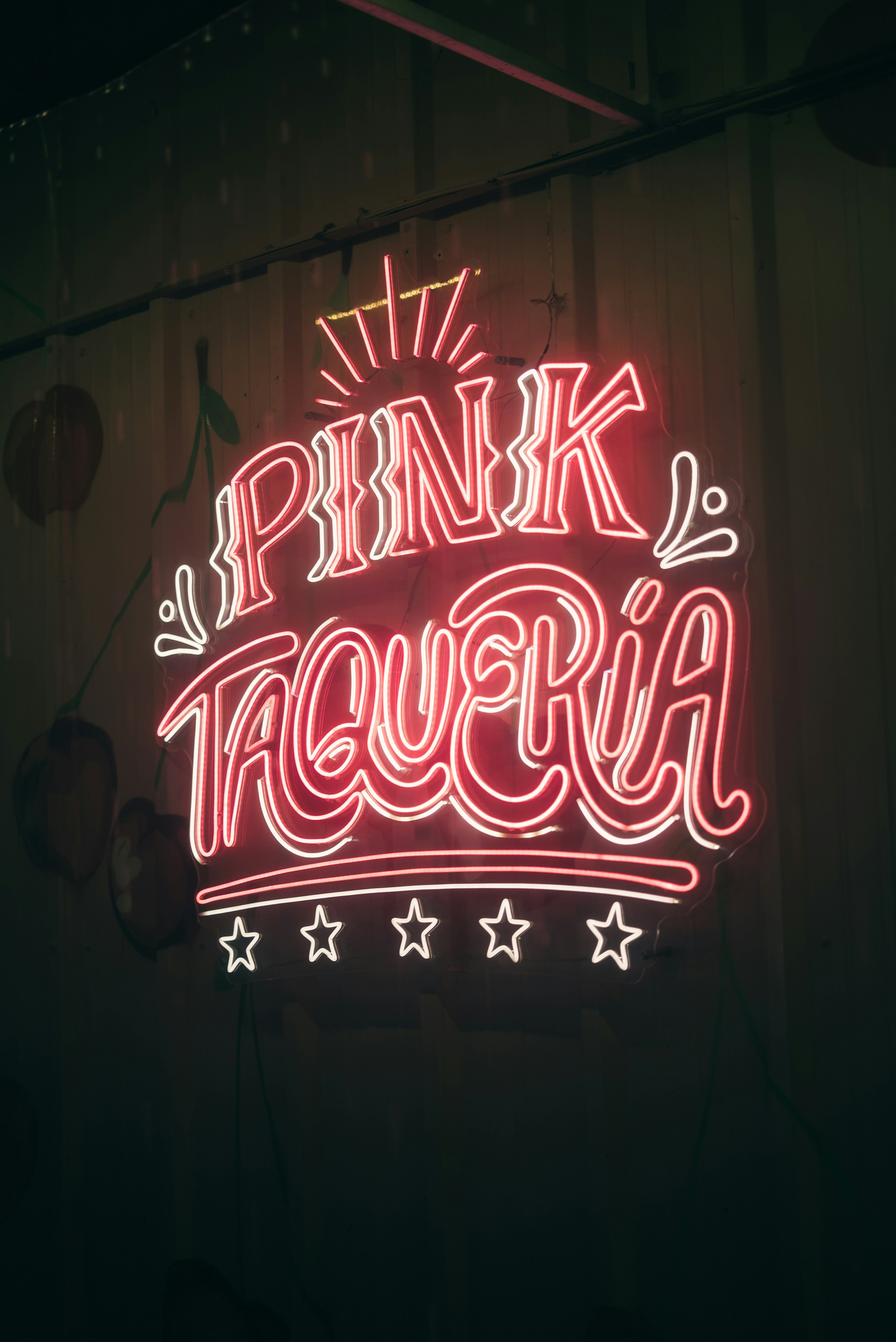 Neon Bloom: Pink Taqueria Sign Bathes the Night