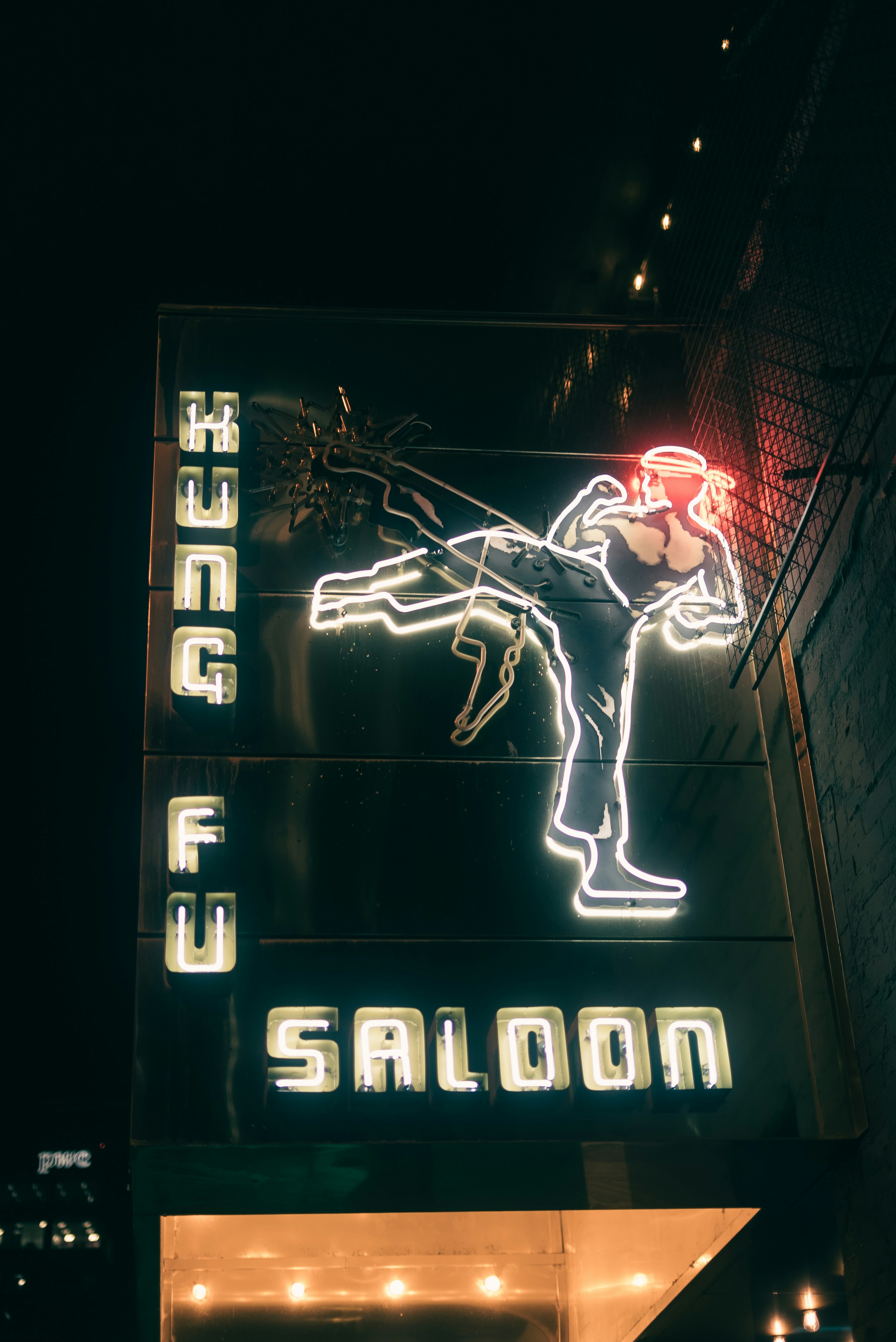 A neon sign for a restaurant called saloon photo – Free Light Image on ...