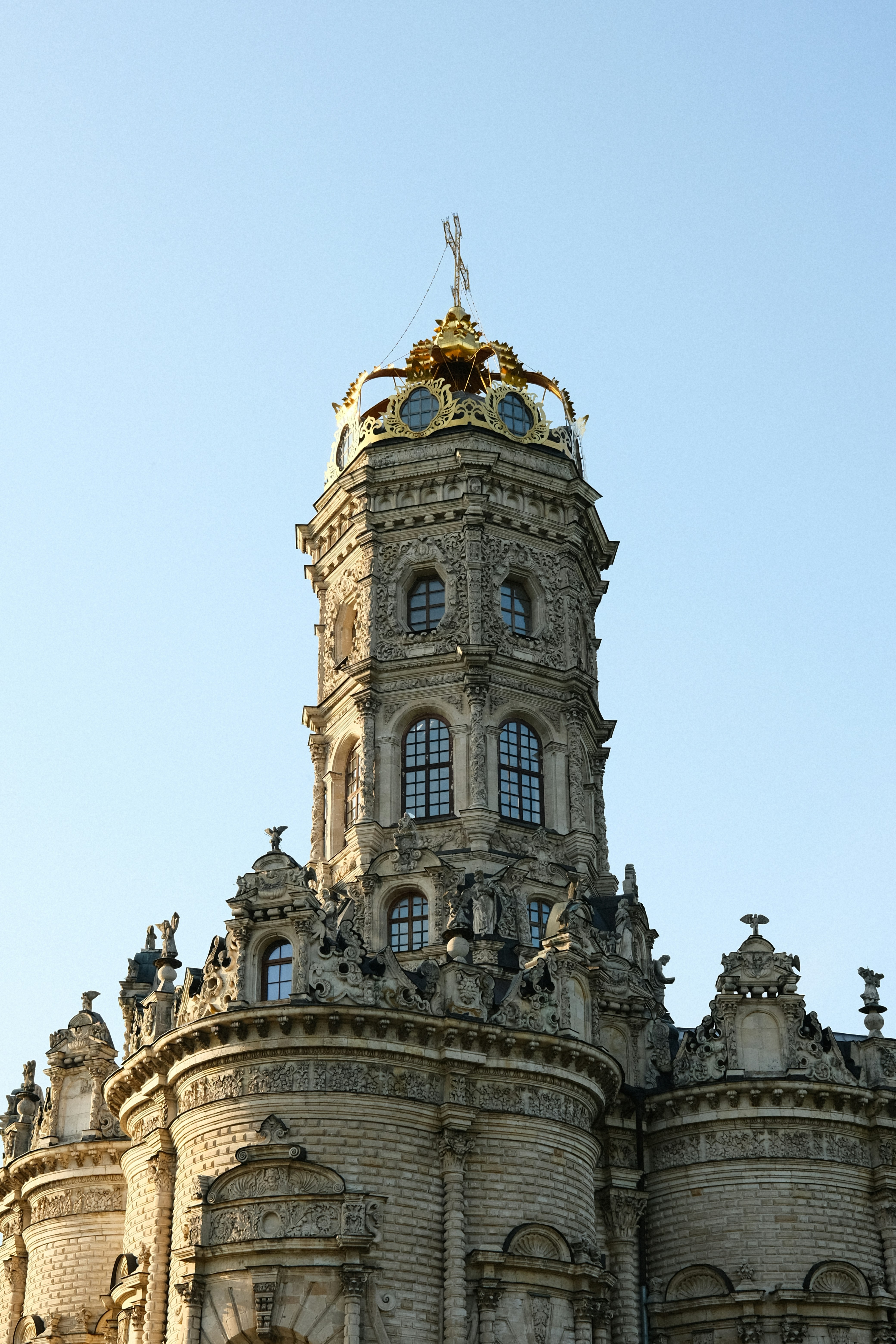 Rising Citadel: Ornate Baroque Clock Tower Against a Clear Blue Sky