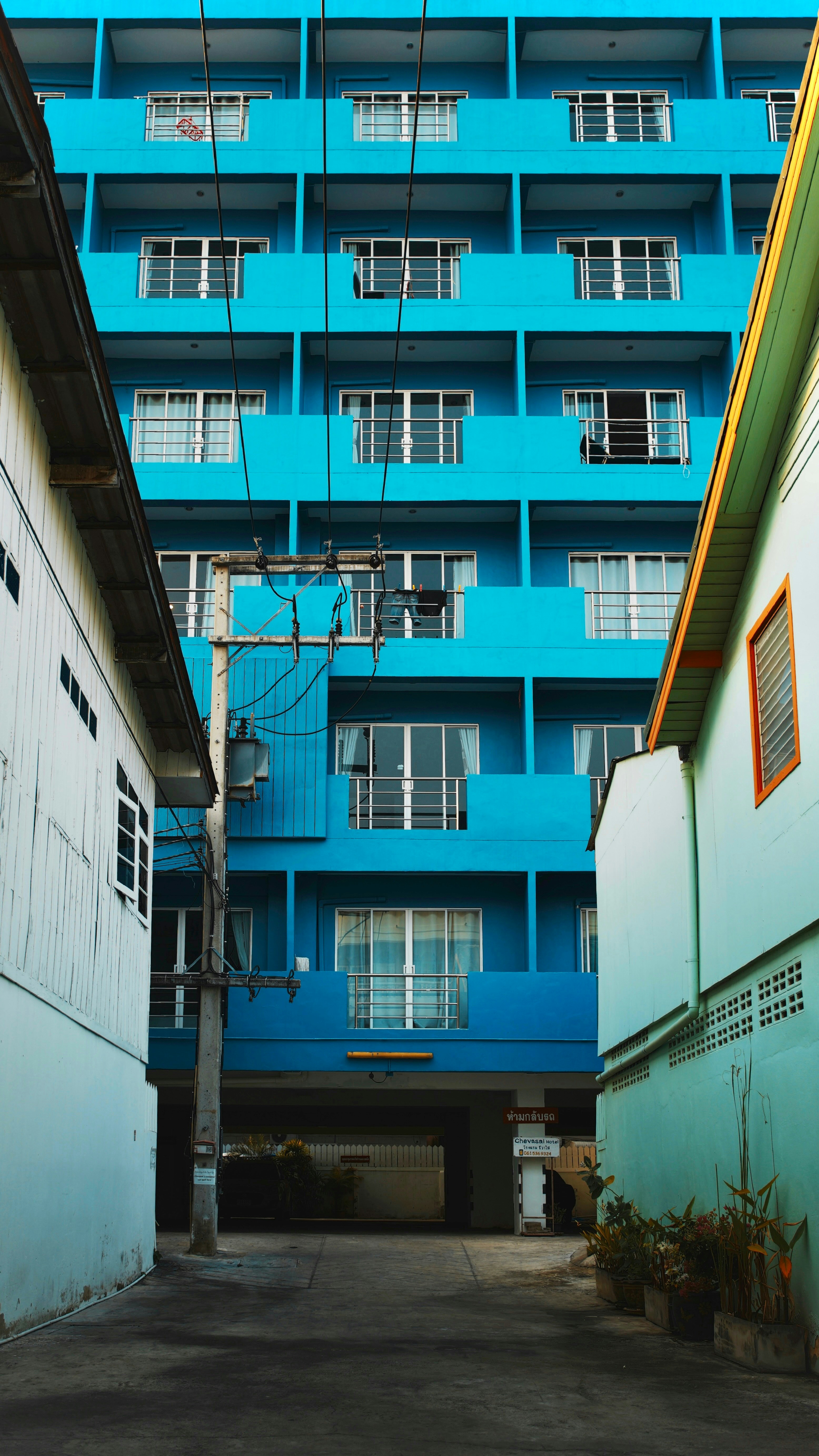 A tall blue building sitting next to a tall white building photo – Free ...