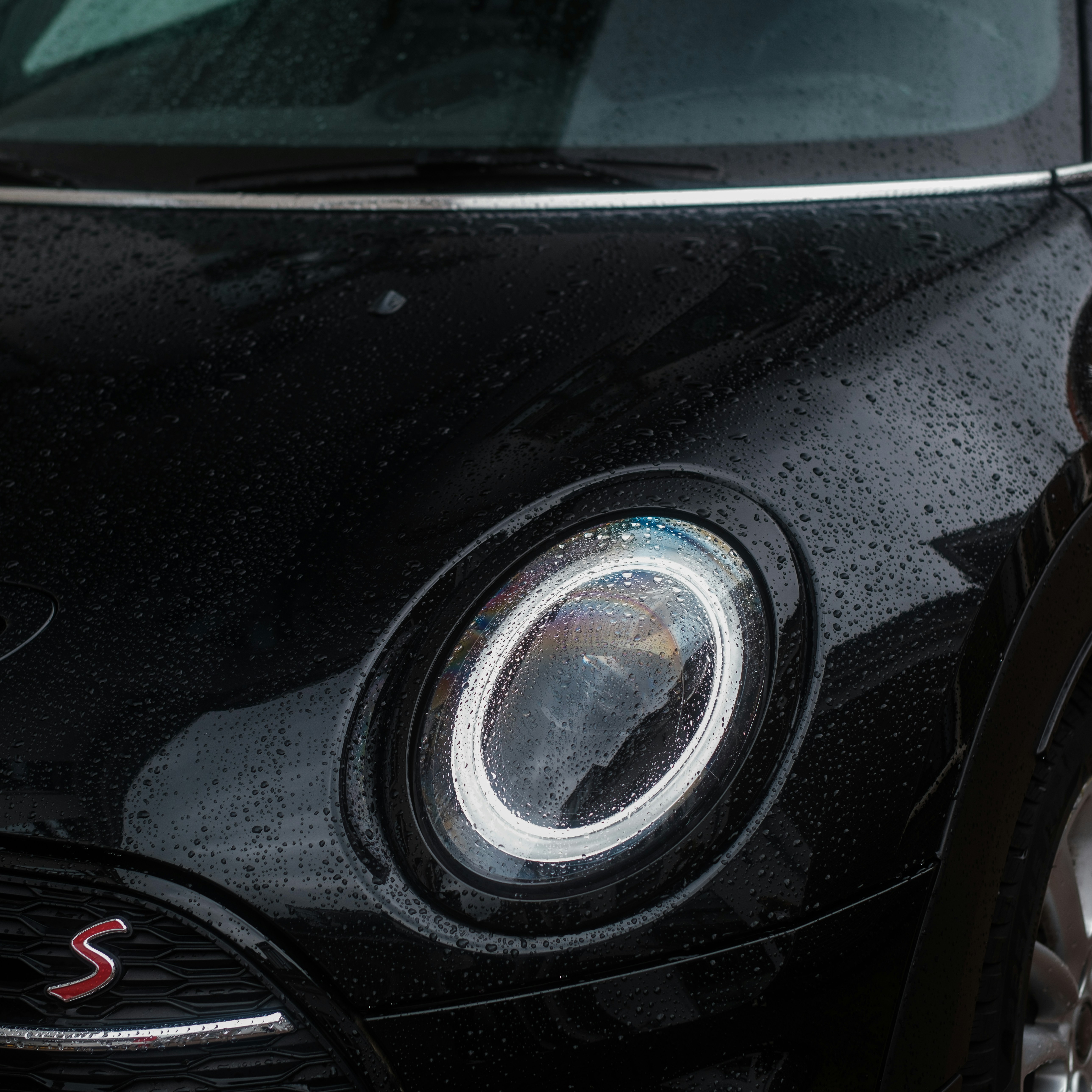 A close up of the front of a black mini cooper cooper cooper cooper ...