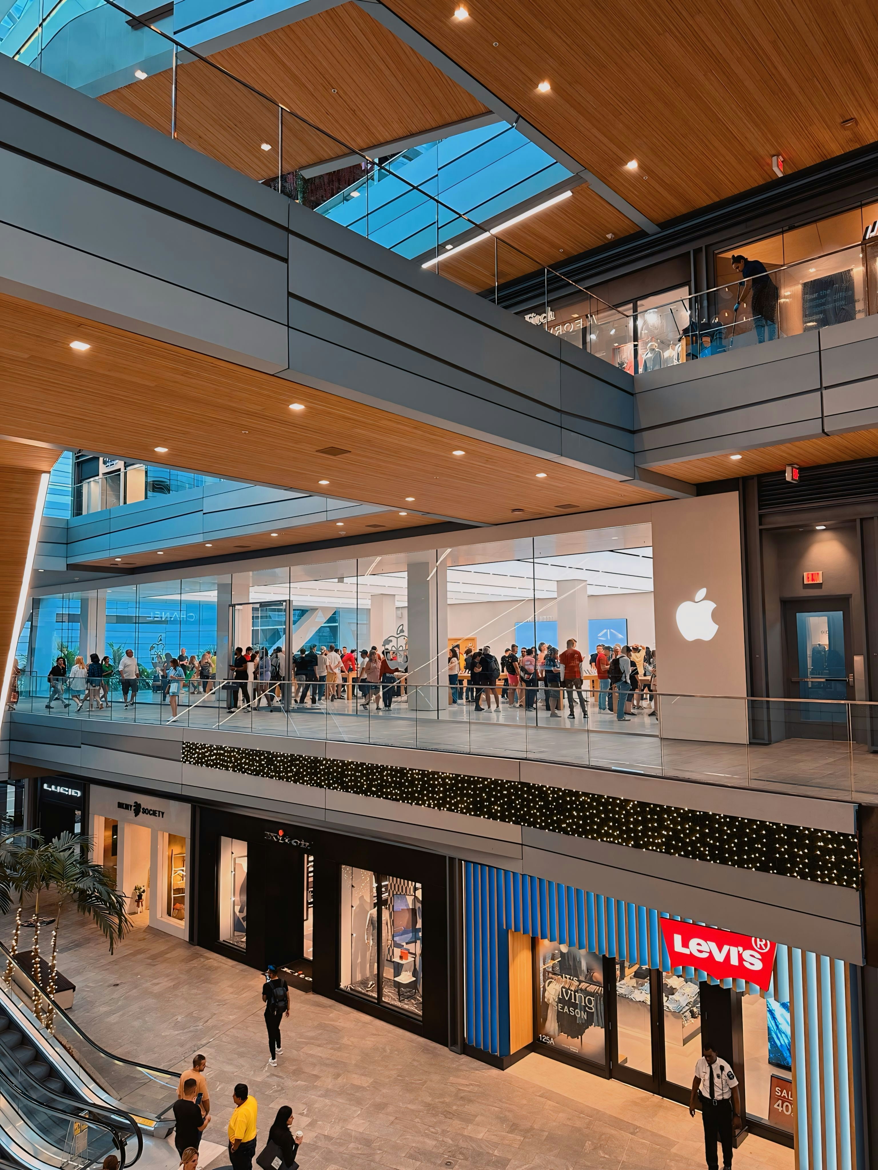 A group of people walking inside of a building photo – Free Human Image ...