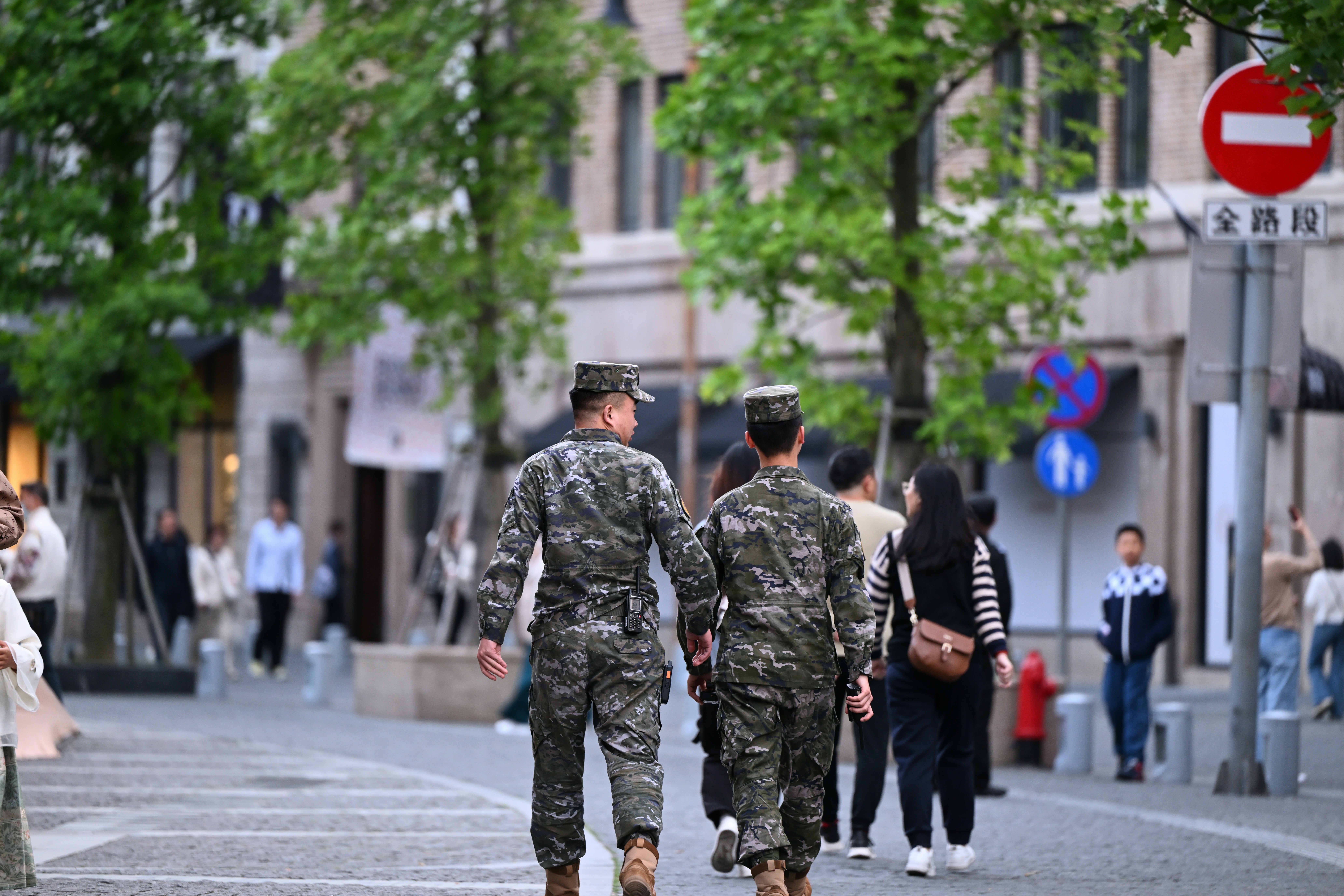 Two soldiers walking down the street in a city photo – Free Luxun park ...